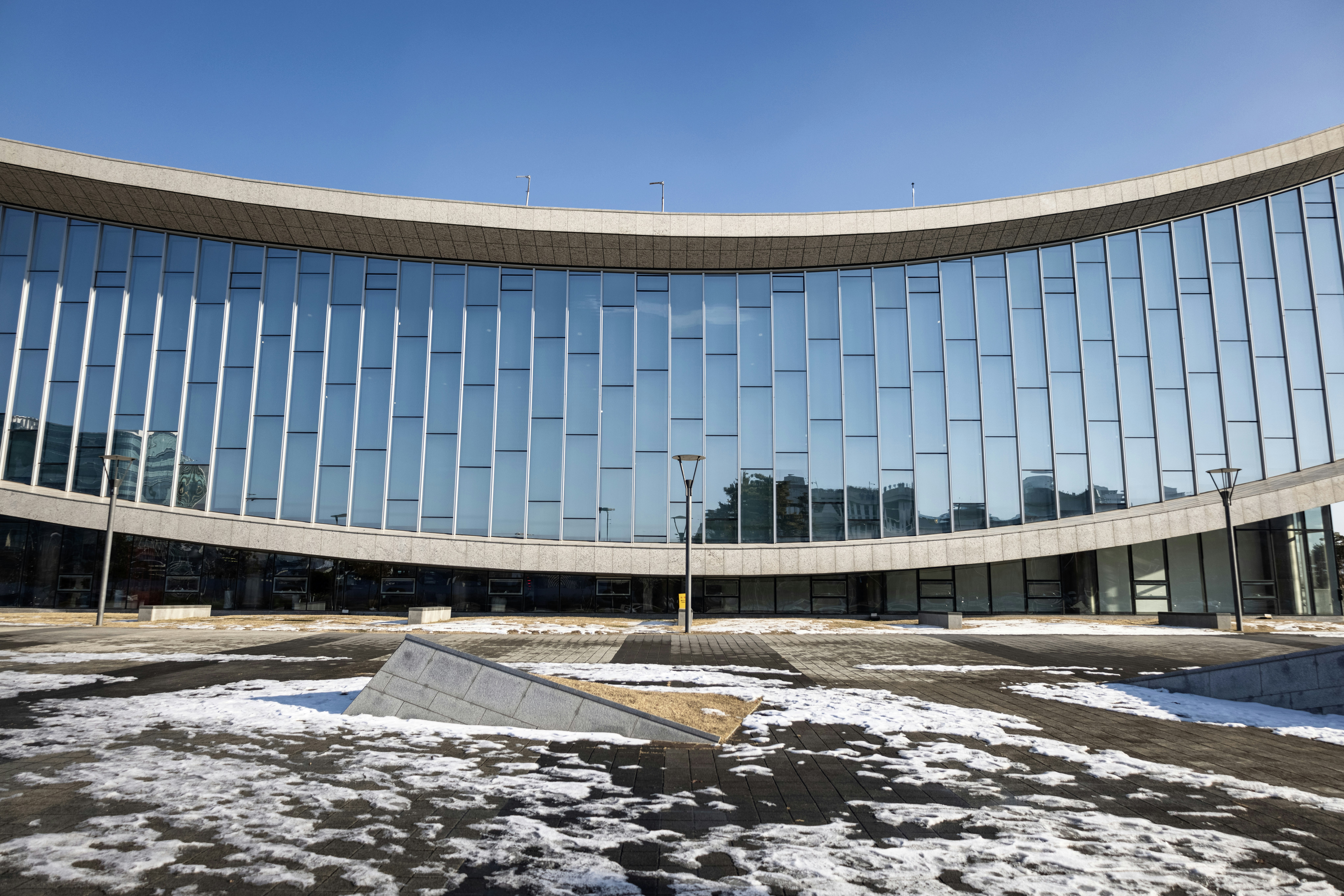 A circular building with a ramp in front of it photo – Free Building ...
