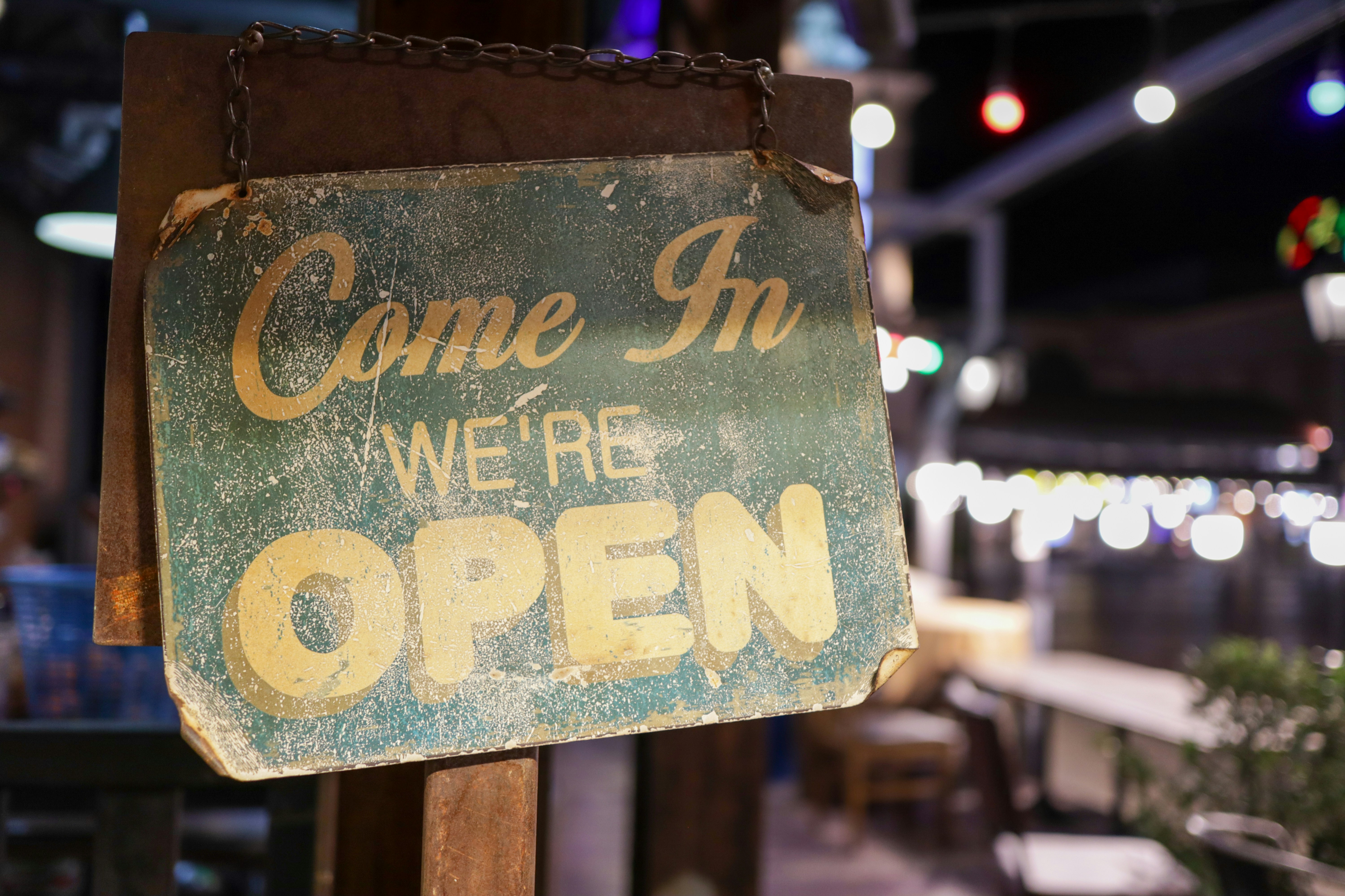 A green and yellow sign that says come in we're open photo – Free Sign ...