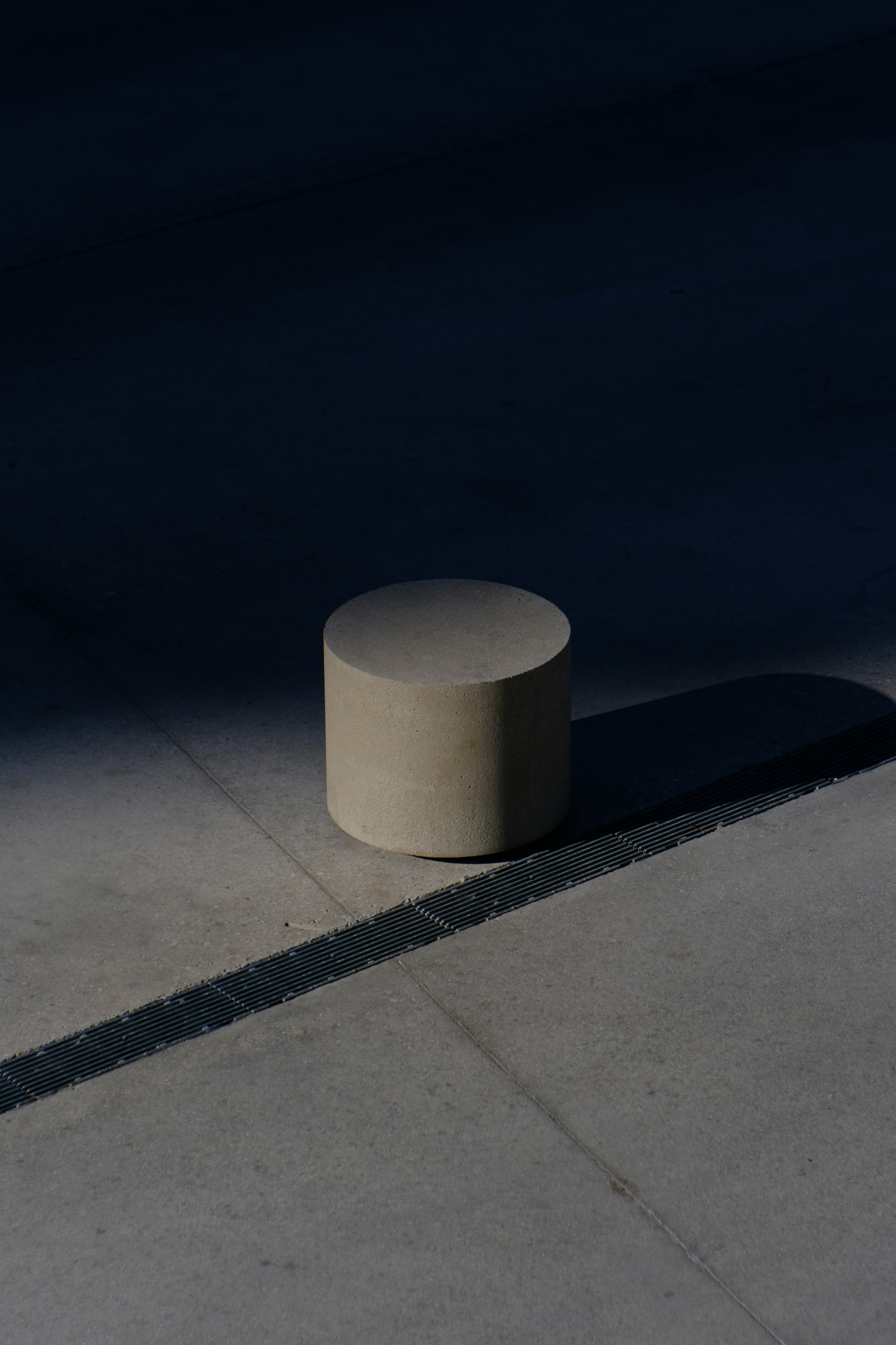 A concrete object is casting a shadow on the ground photo – Free ...