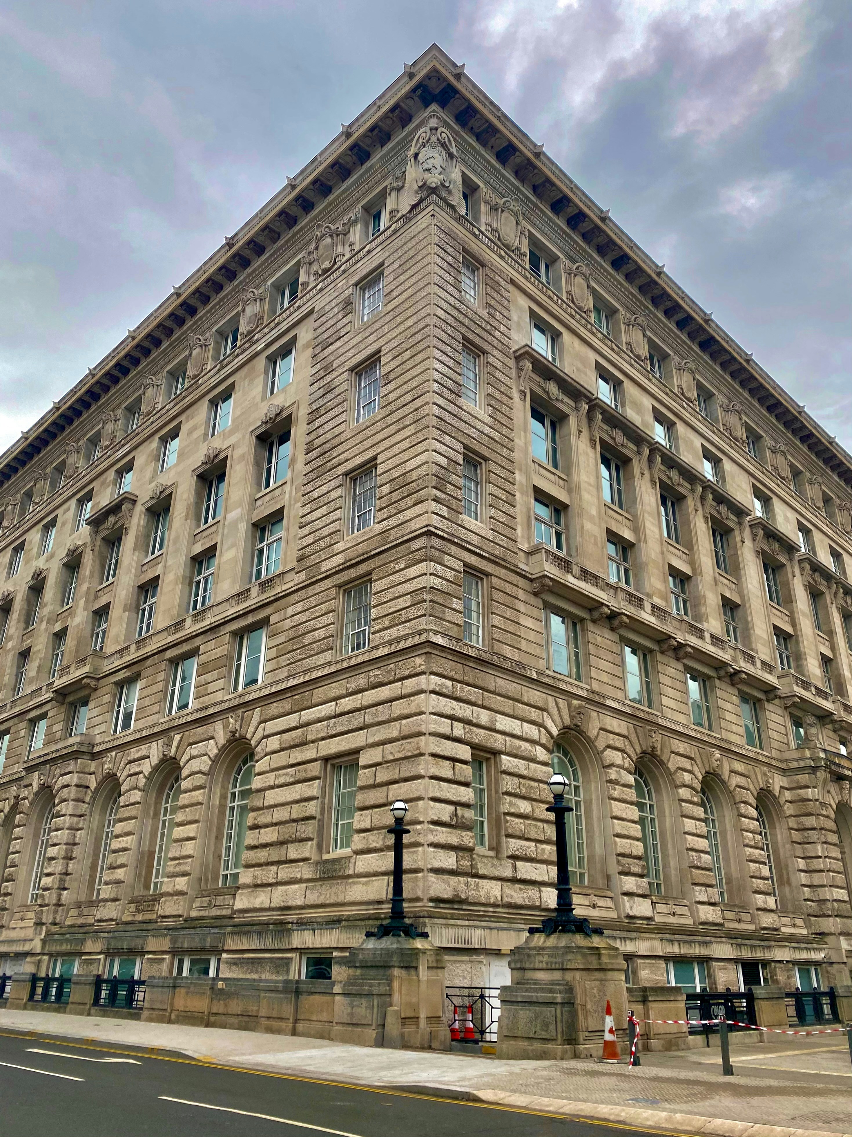 A very tall building sitting on the side of a road photo – Free ...
