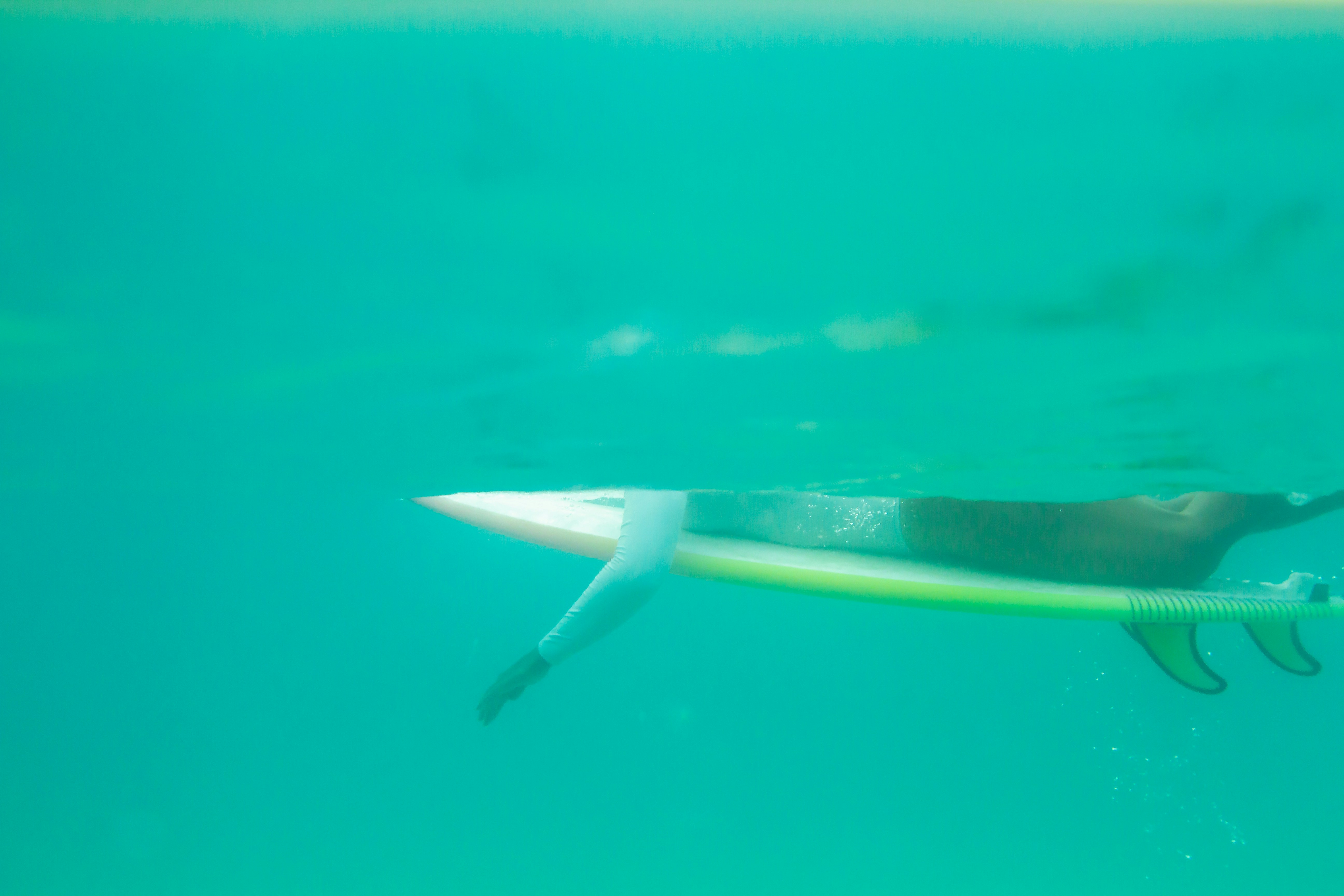 Underwater Edge: White Board Crest Drifting in Aquamarine Silence