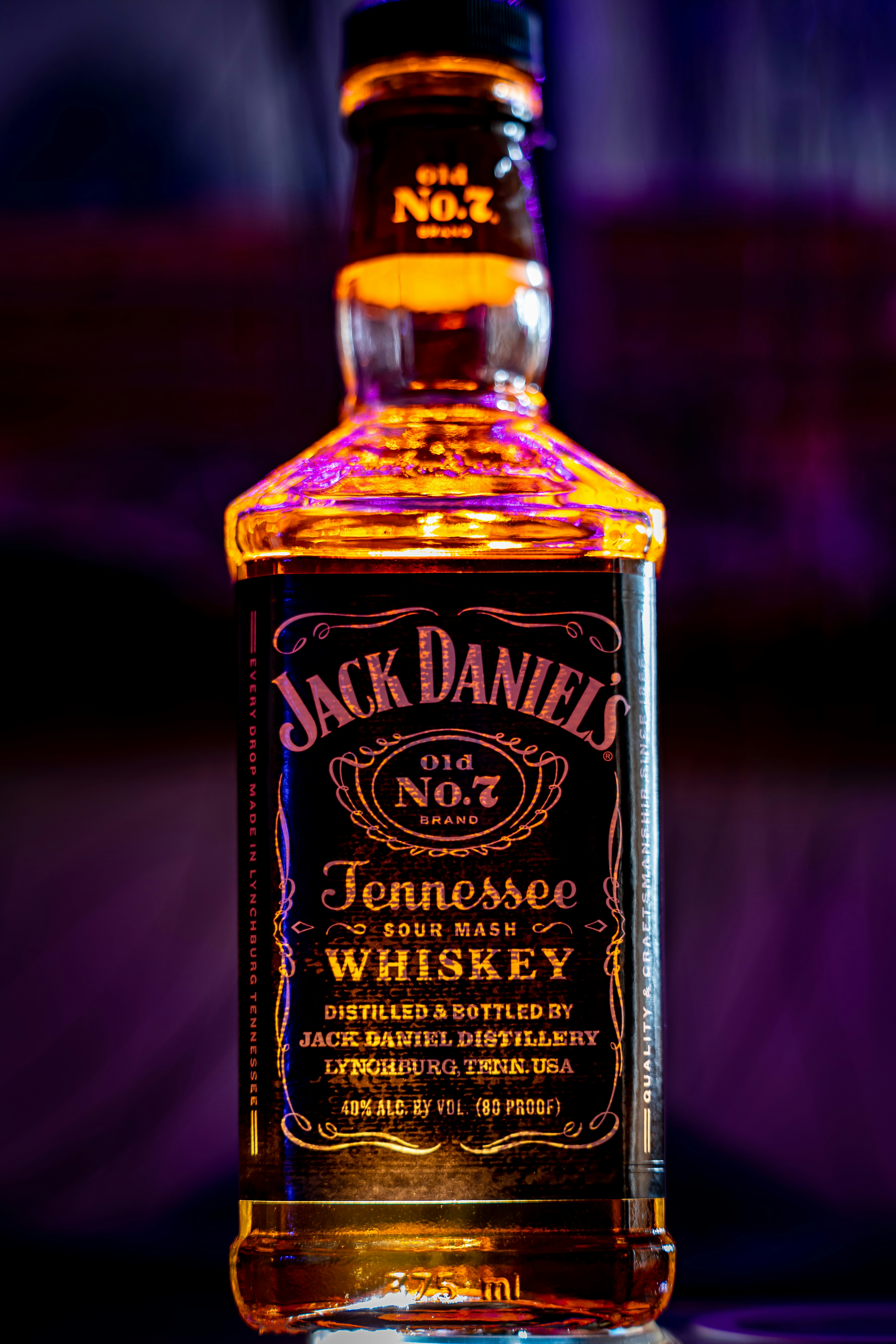 A bottle of jack daniels whiskey sitting on a table photo – Free ...