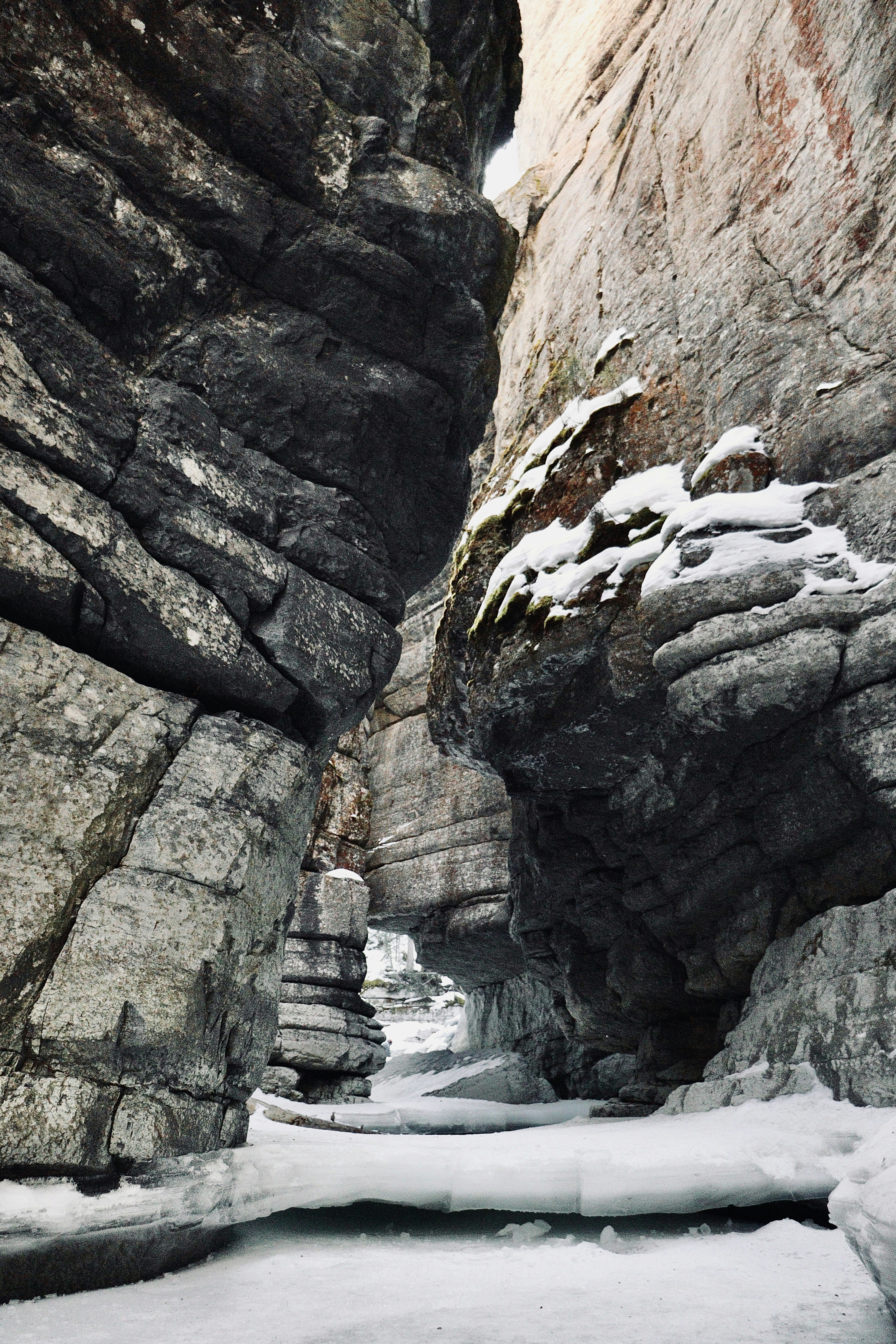 A narrow rocky path with snow on the ground photo – Free Slate Image on ...