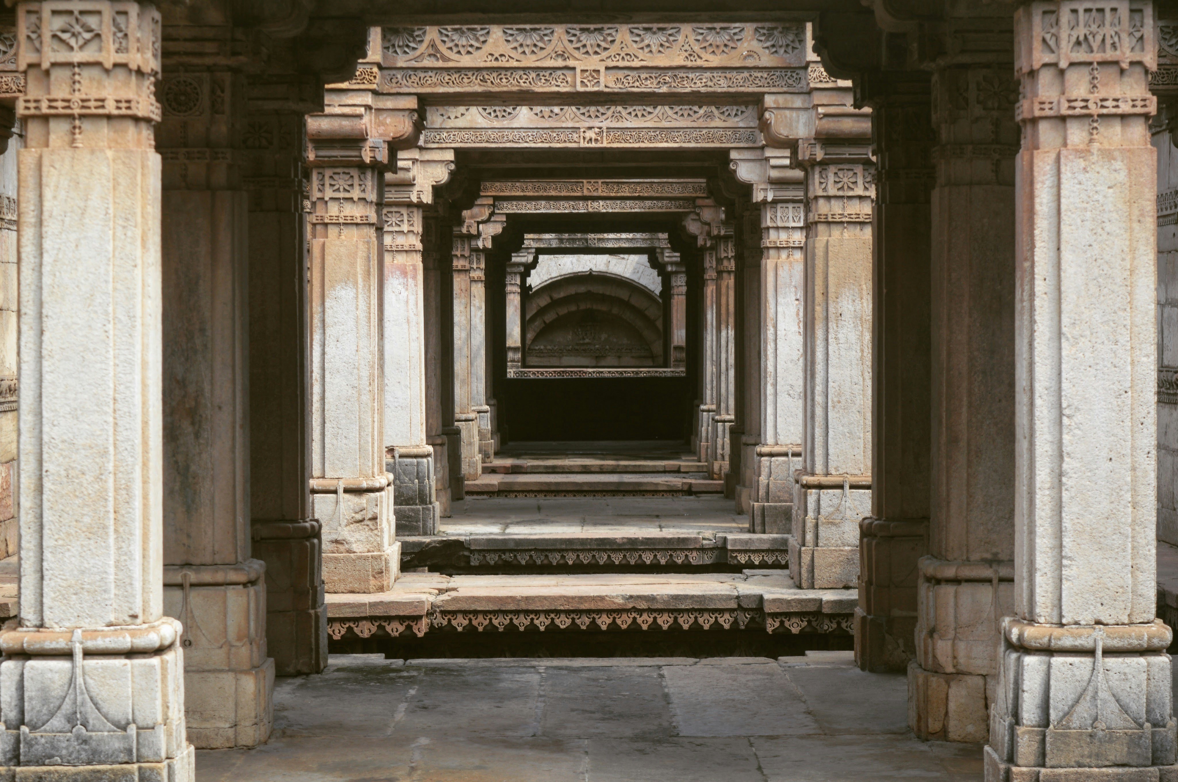 A stone structure with pillars and a doorway photo – Free Building ...