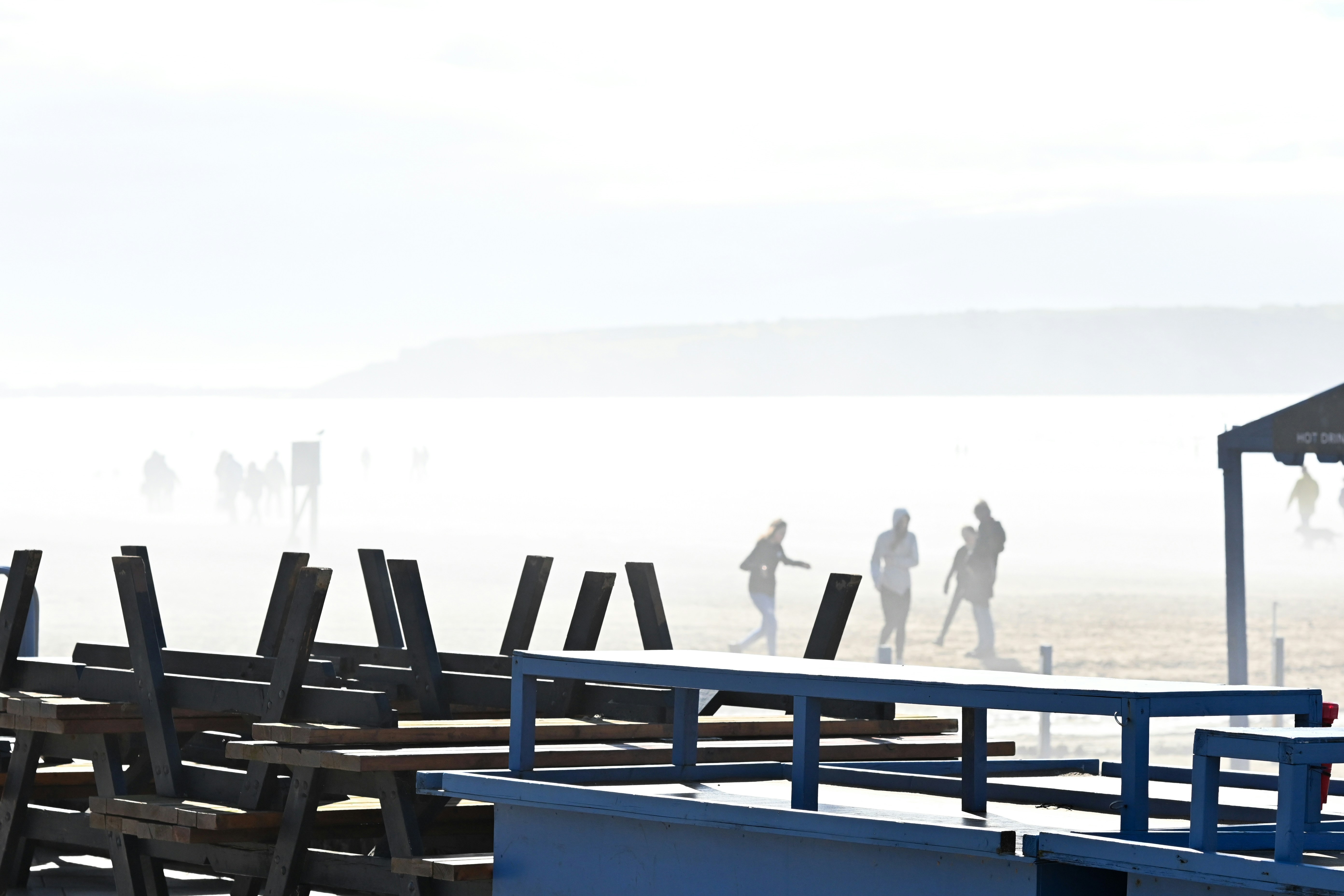 Ghostly Figures Amid Beach Haze