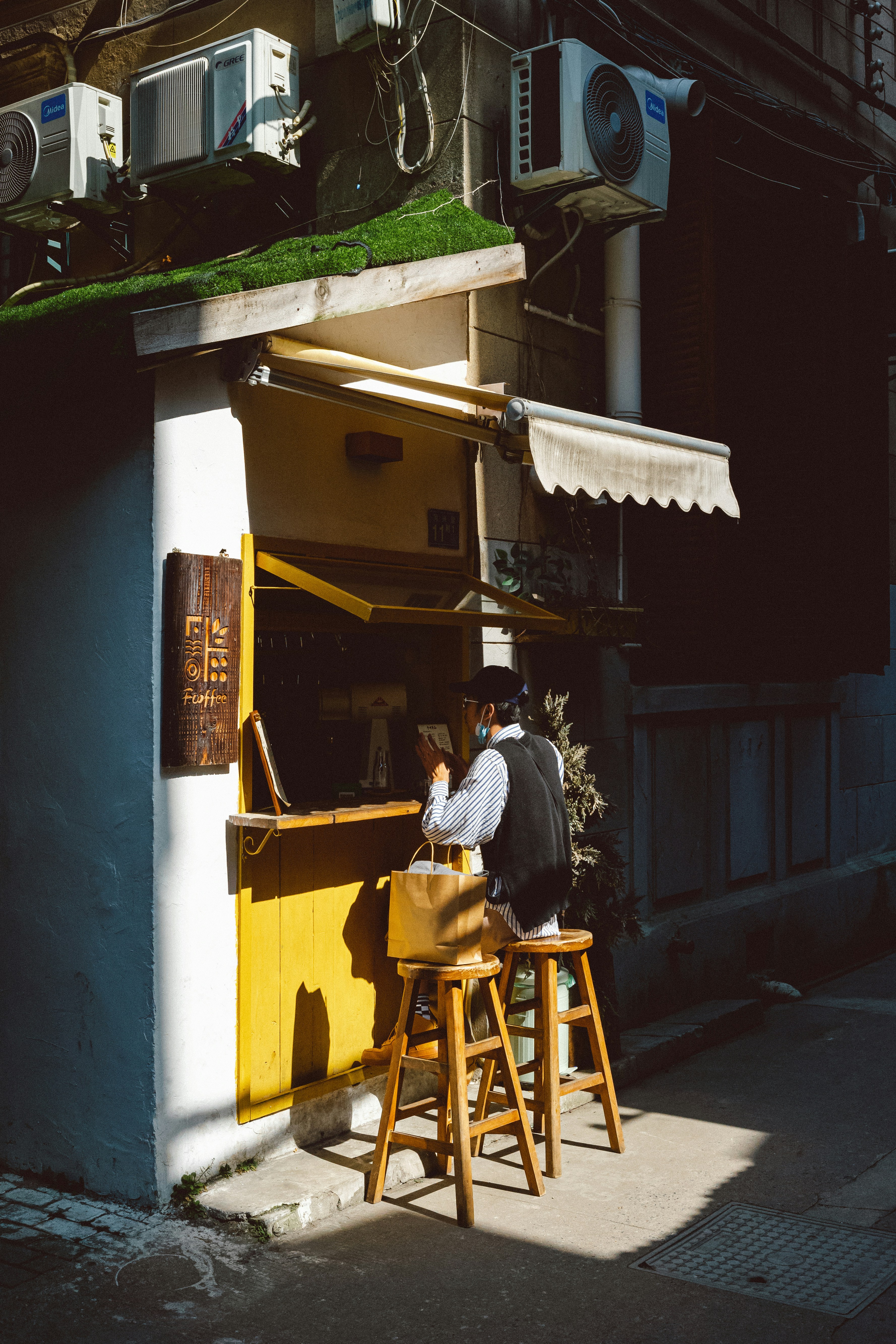 a man sitting at a table in front of a building