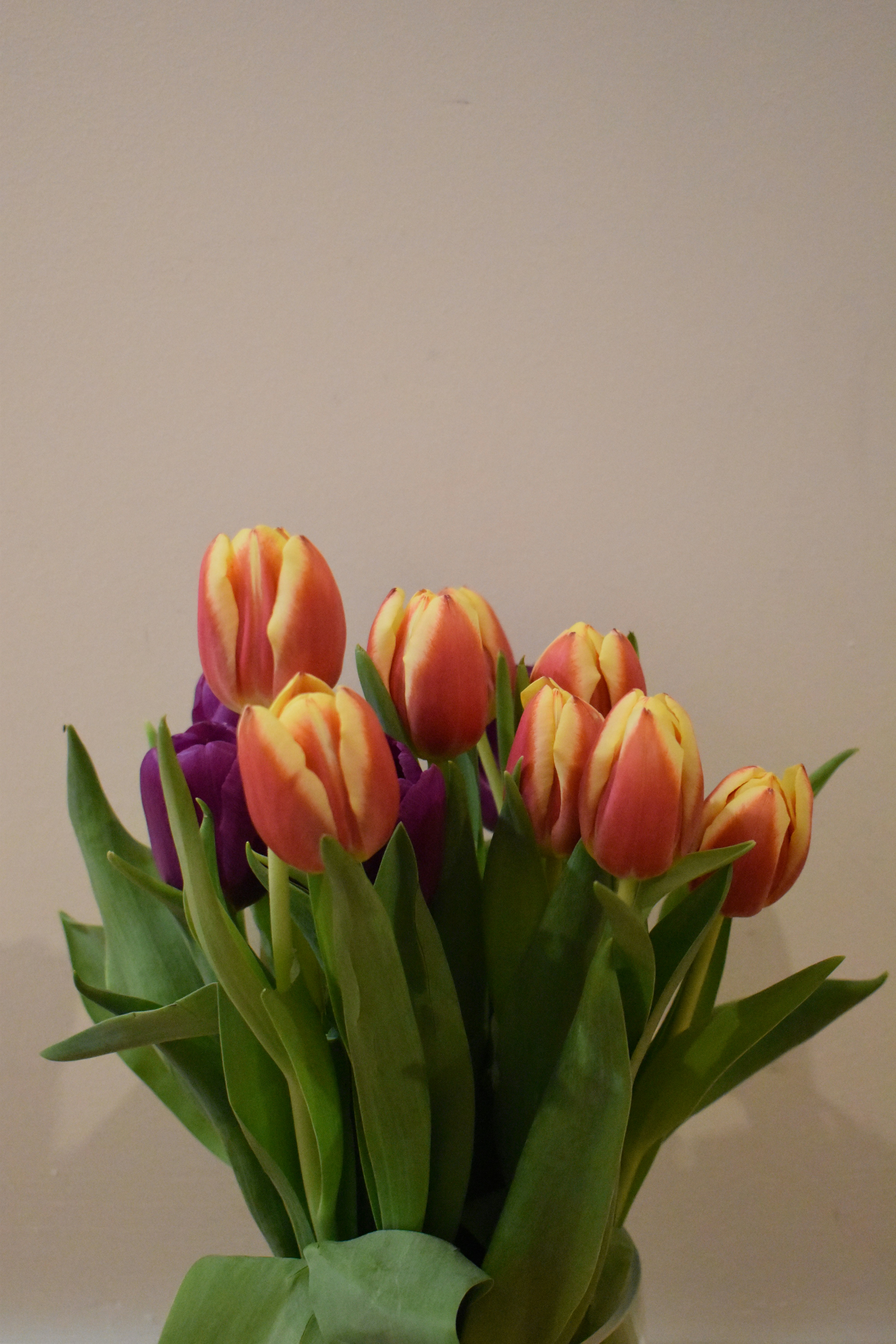 a vase filled with lots of flowers on top of a table