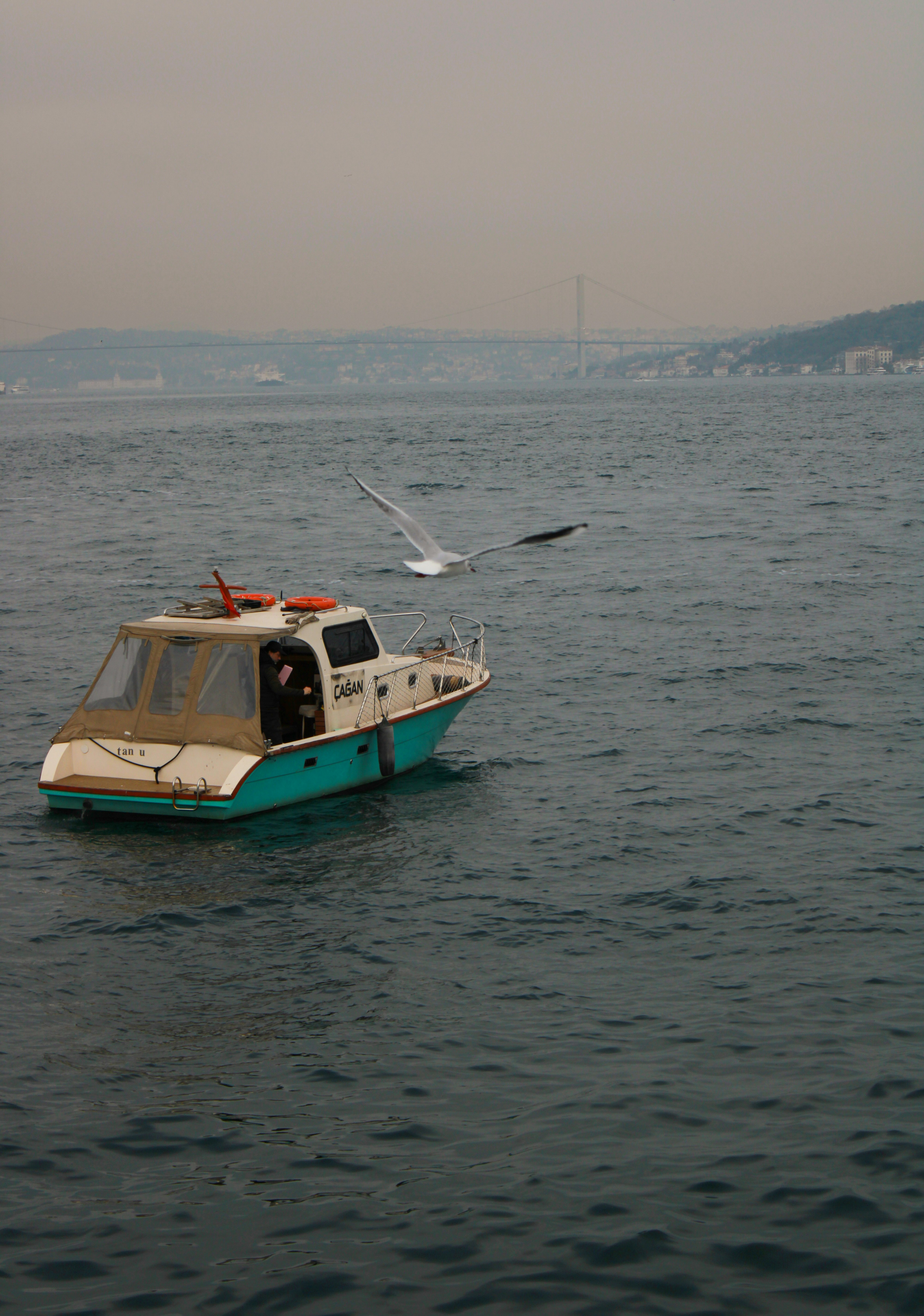 a small boat floating on top of a large body of water