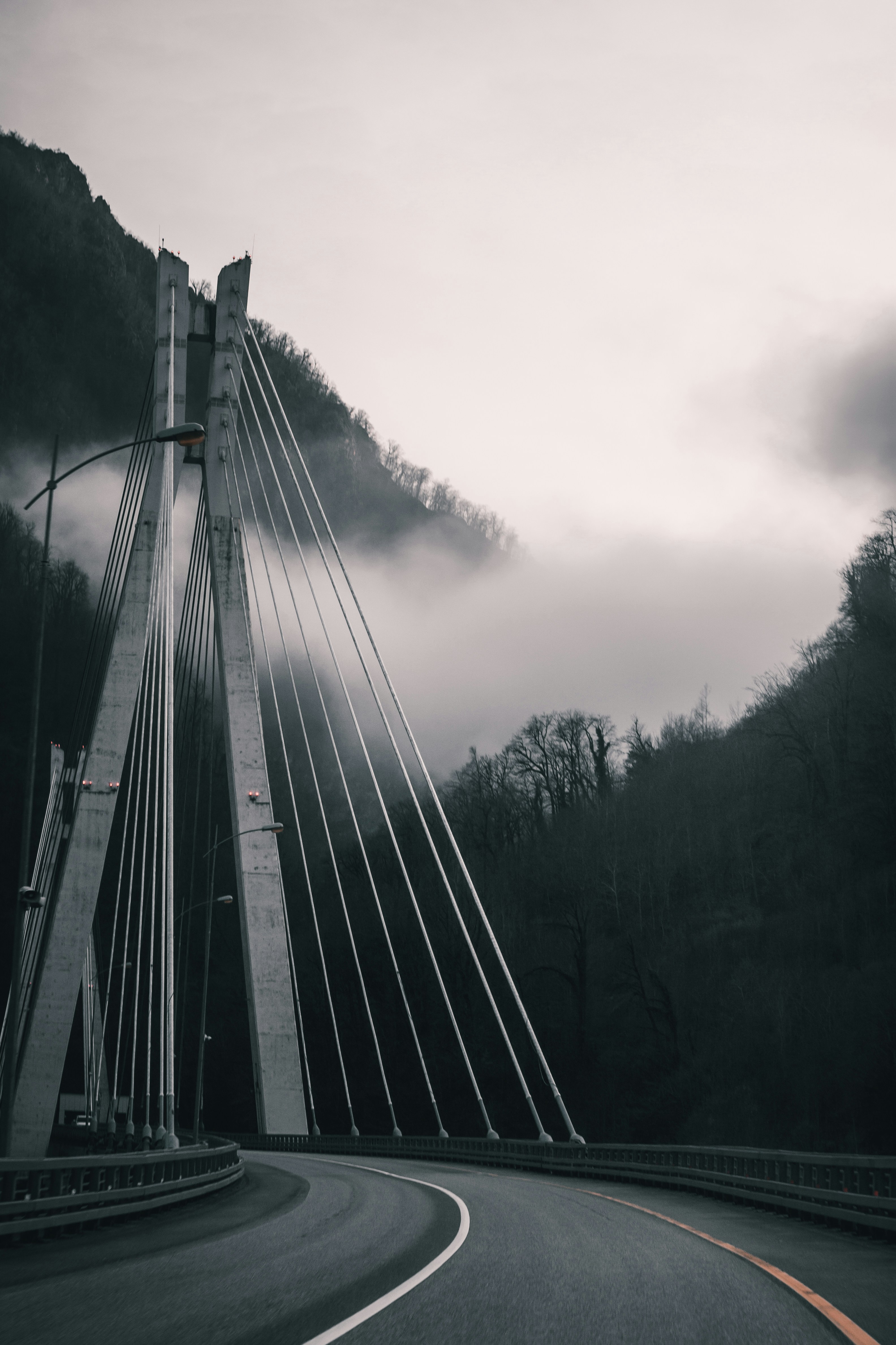 A very tall bridge spanning over a road photo – Free Art Image on Unsplash