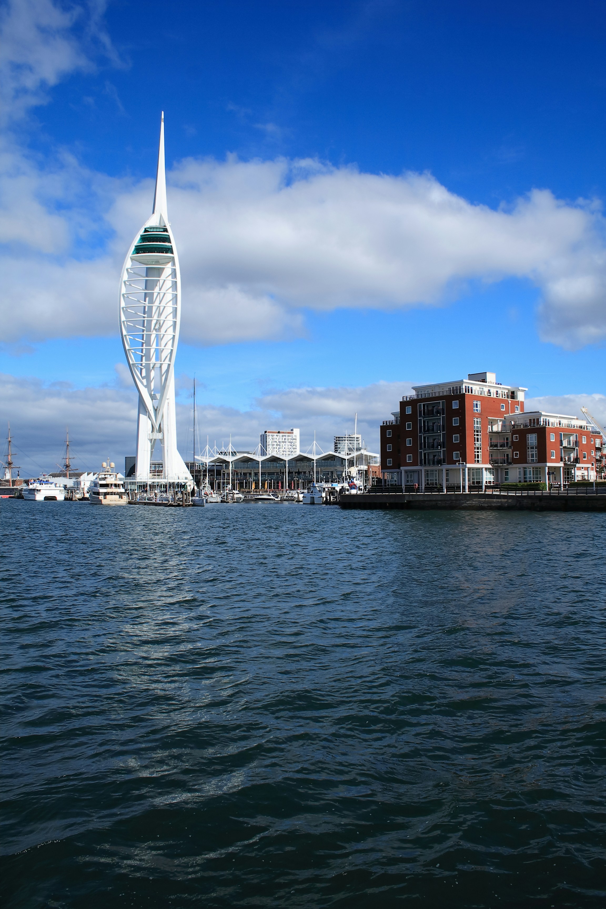 Harbor Sentinel: The Sail-Tower Reaching Over a Quiet Waterfront