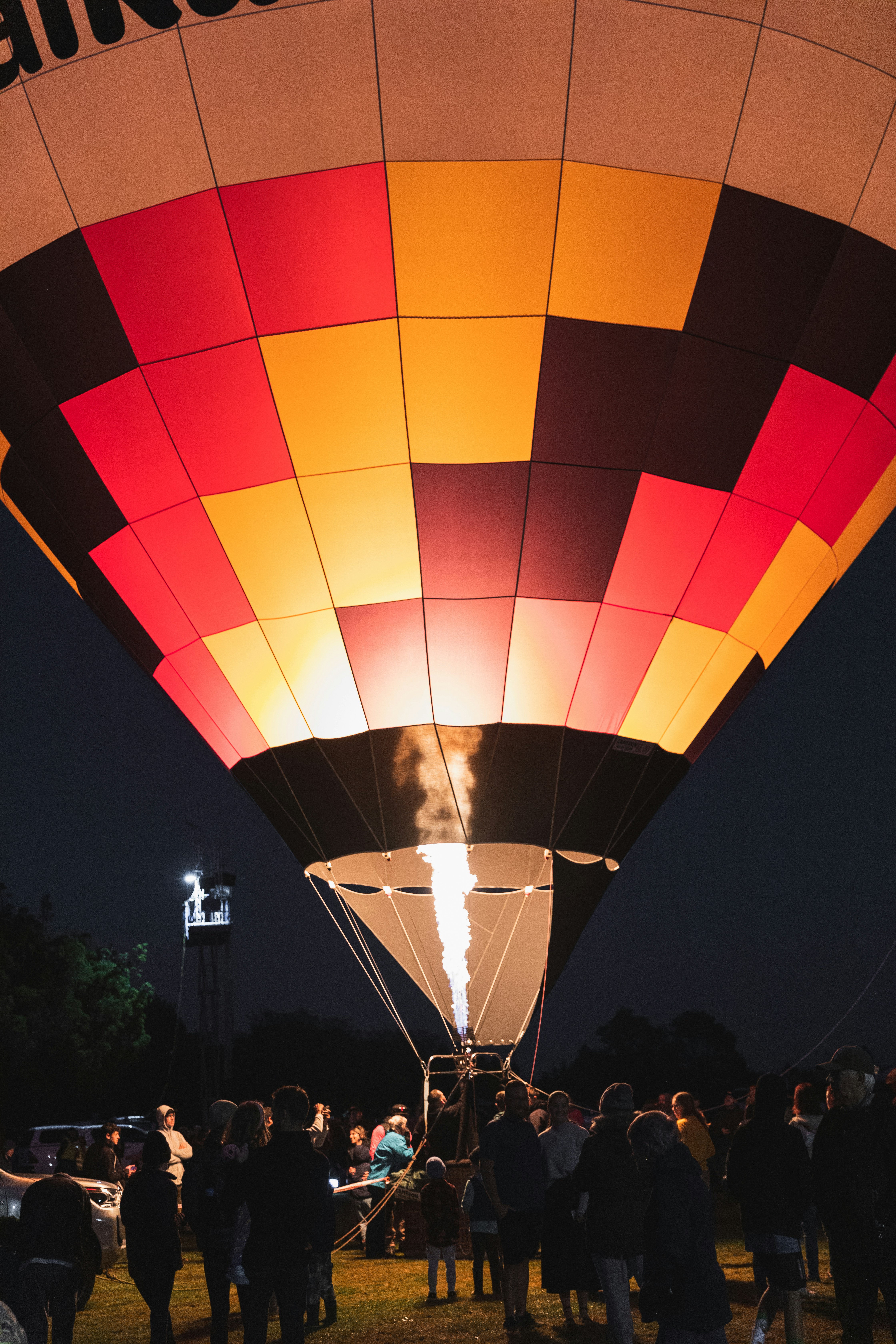 A group of people standing around a hot air balloon photo – Free ...