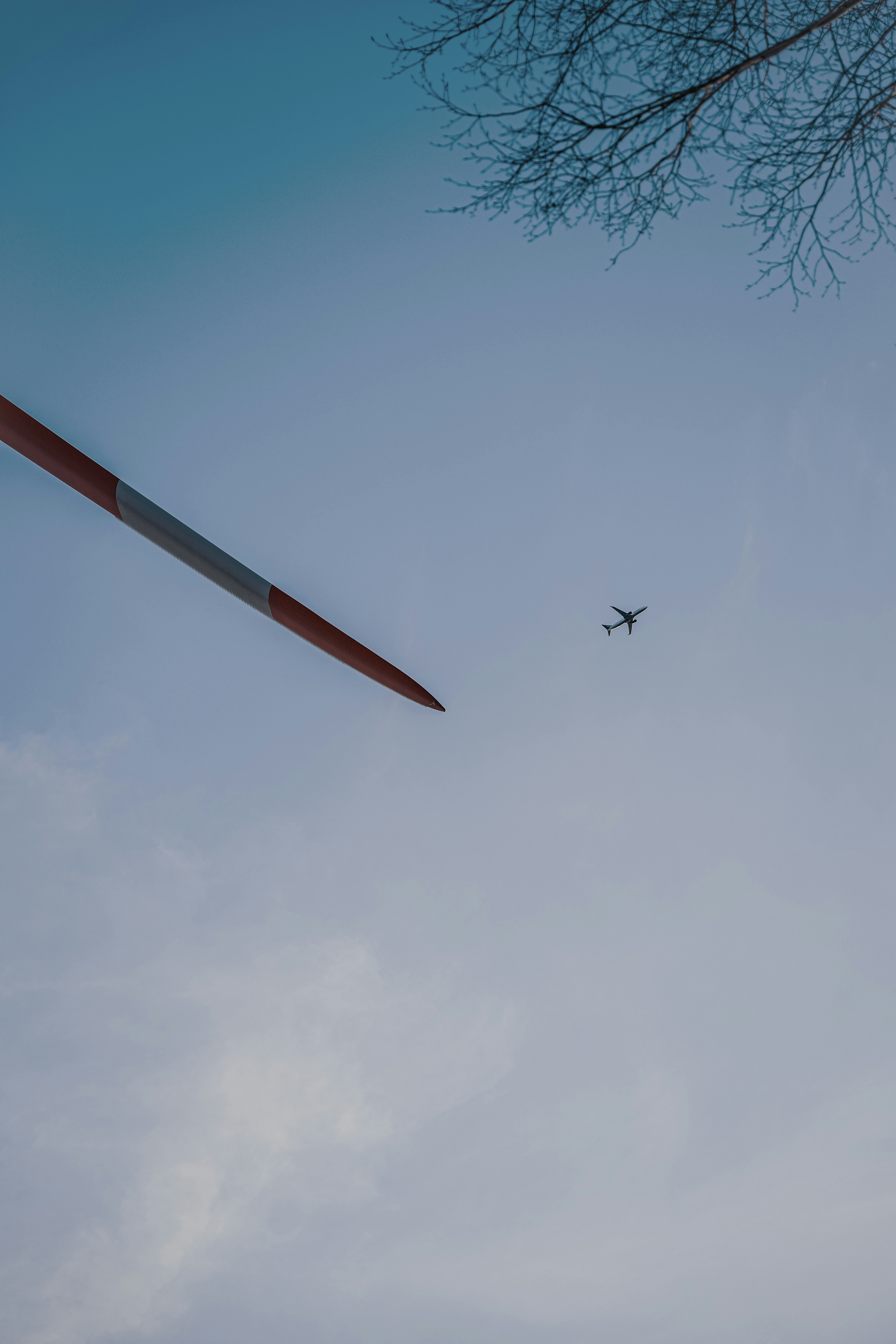 a plane flying in the sky with a long tail