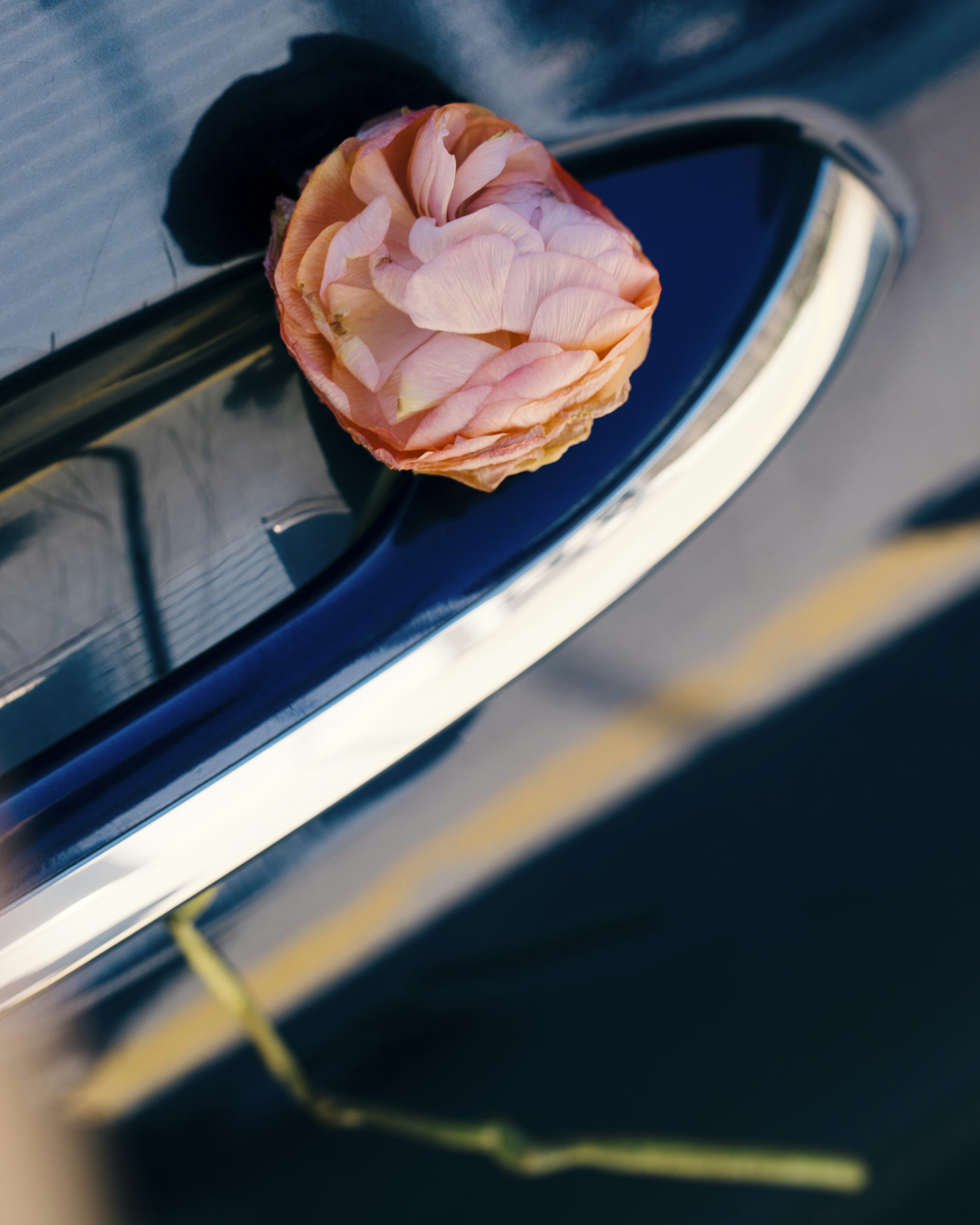 a car door handle with a flower sticking out of it