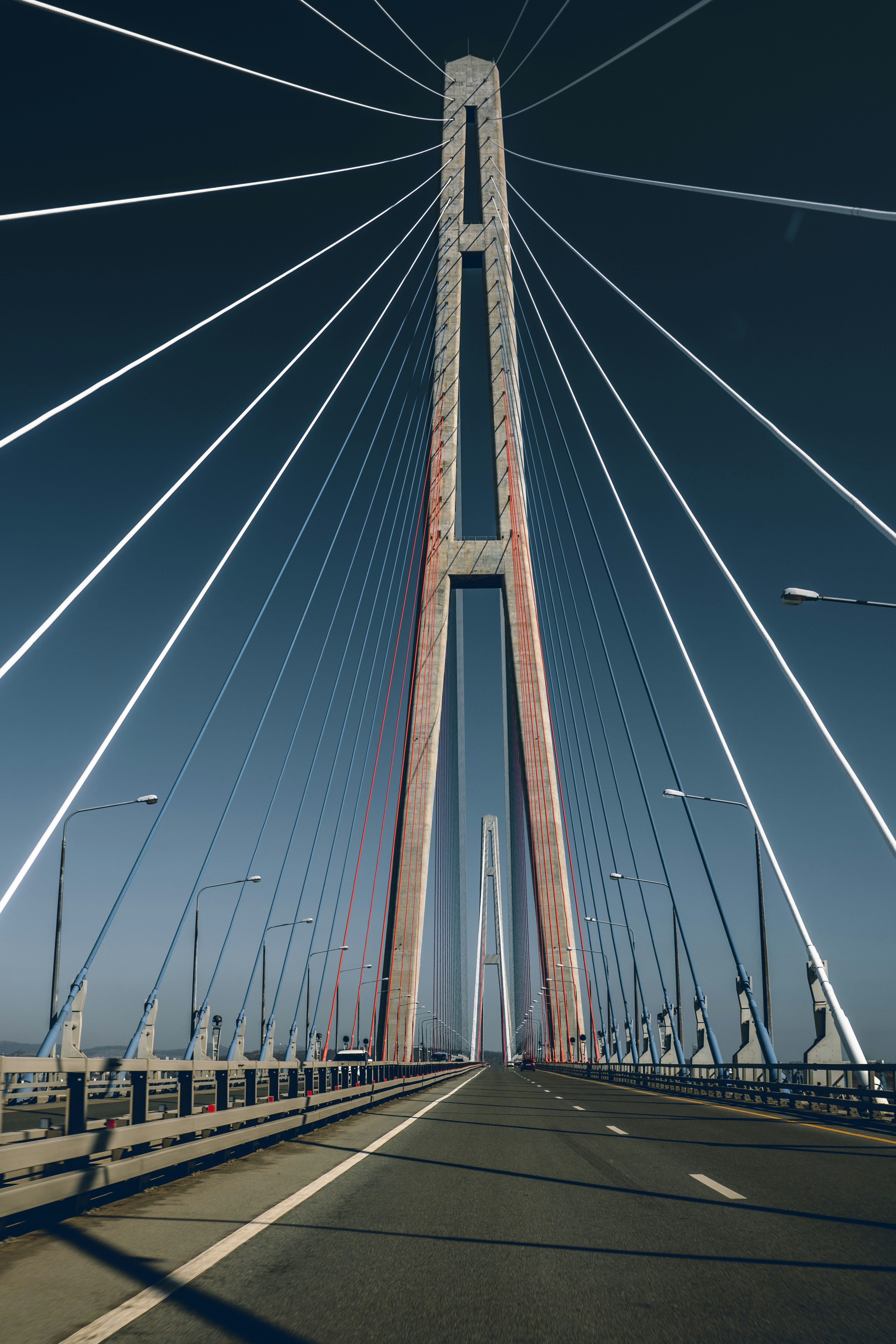 a view of a very tall bridge from a car