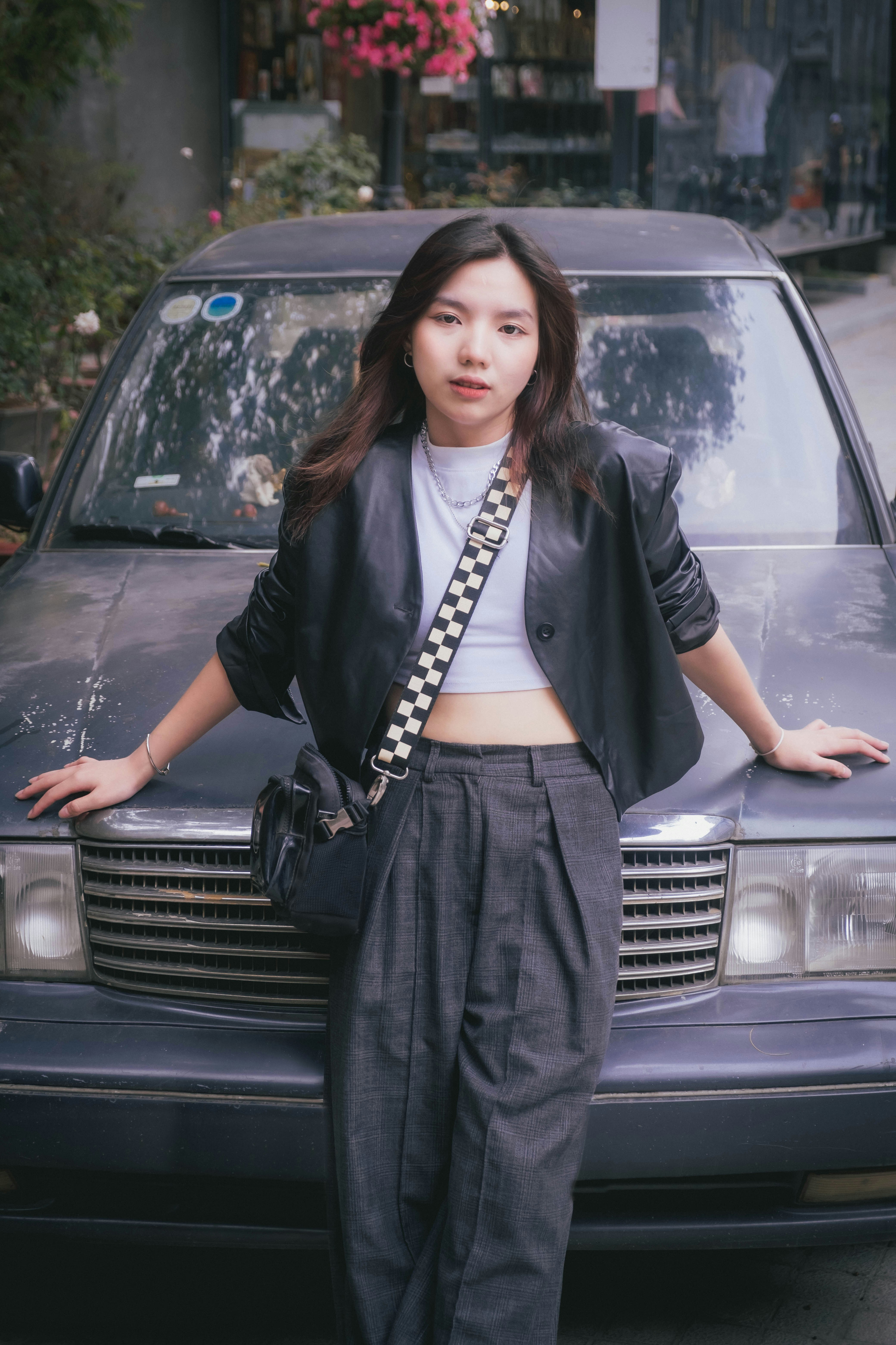 Urban Quiet: A Streetwear Moment Leaning on a Weathered Car