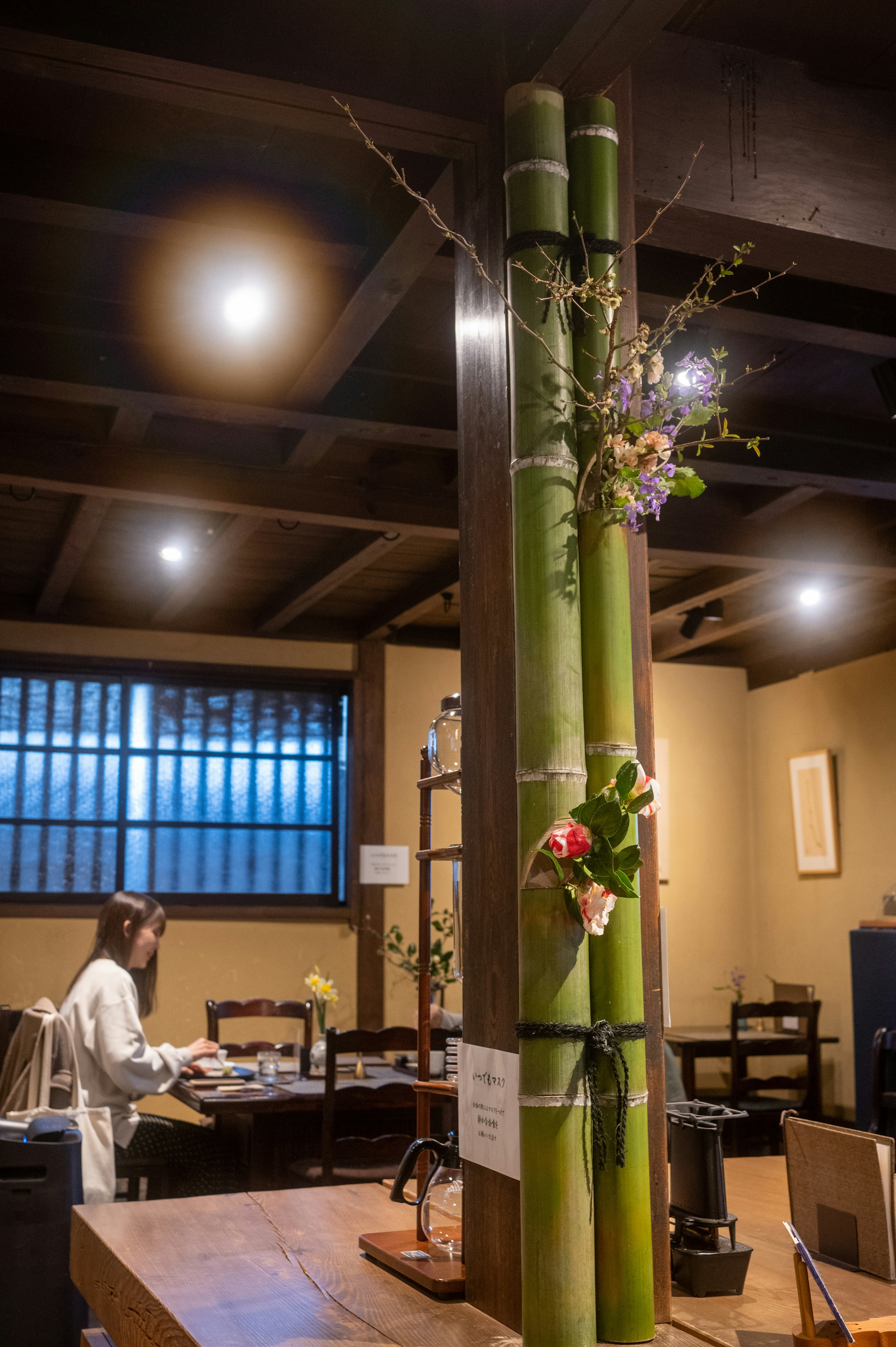 a woman is sitting at a table in a restaurant