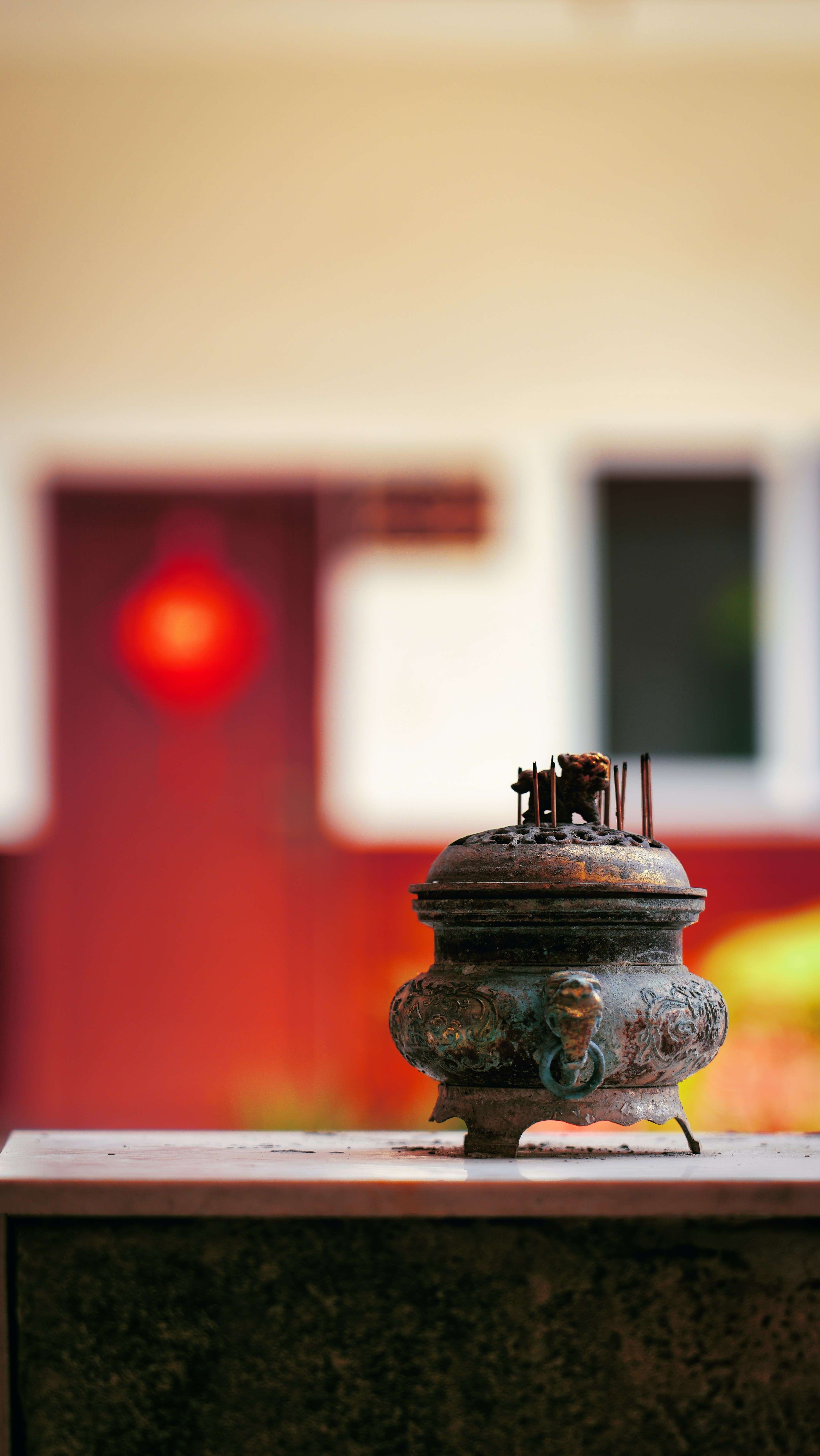 Weathered burner in focus: a rusty relic against a soft-windowed background