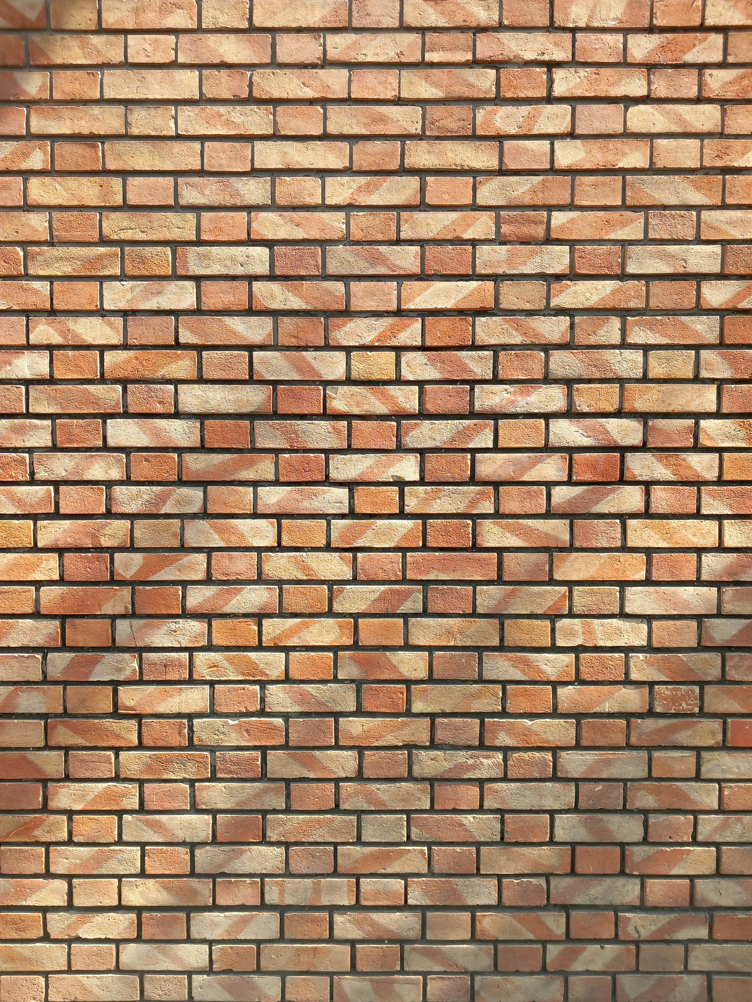 a red brick wall with a clock on it