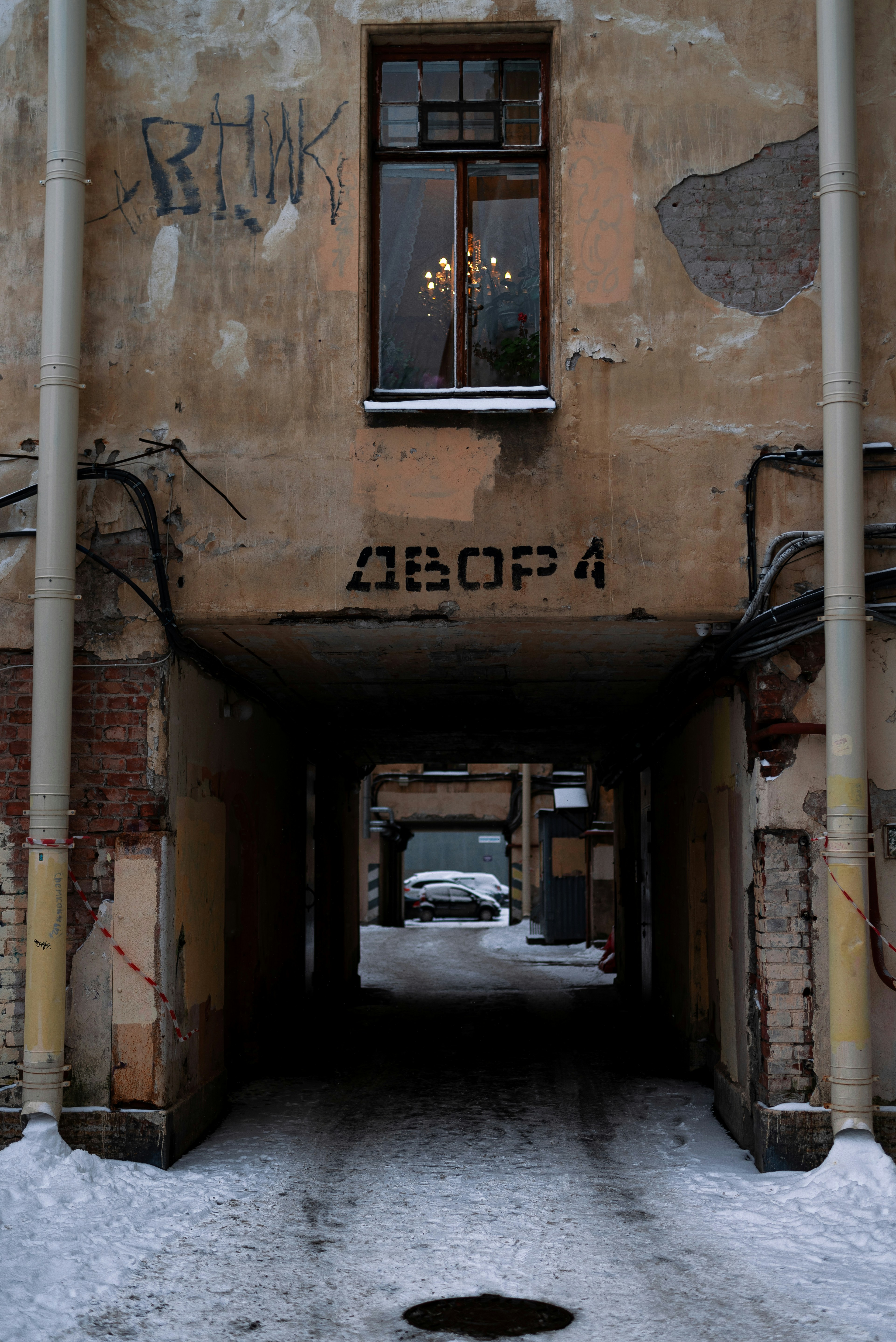 Tunnel of Echoes: A Snow-Soft Corridor Beneath a Weathered Facade