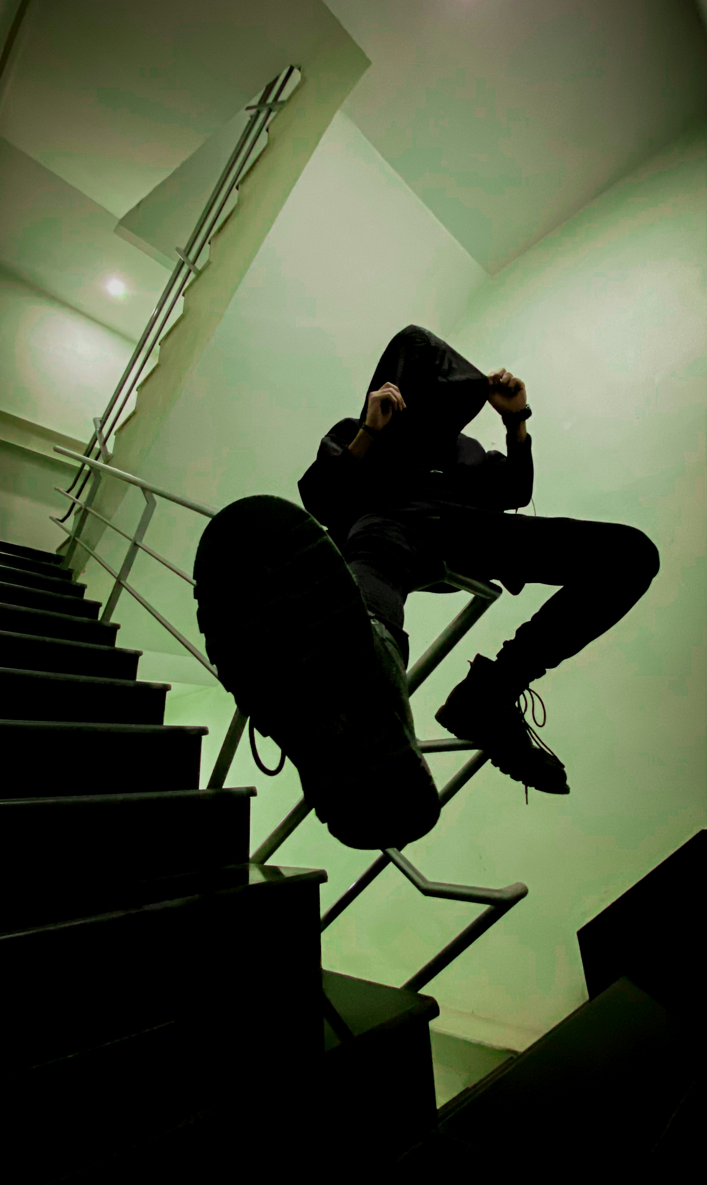 Midair Stealth: A Sneaker-Clad Figure Leaping the Stairwell