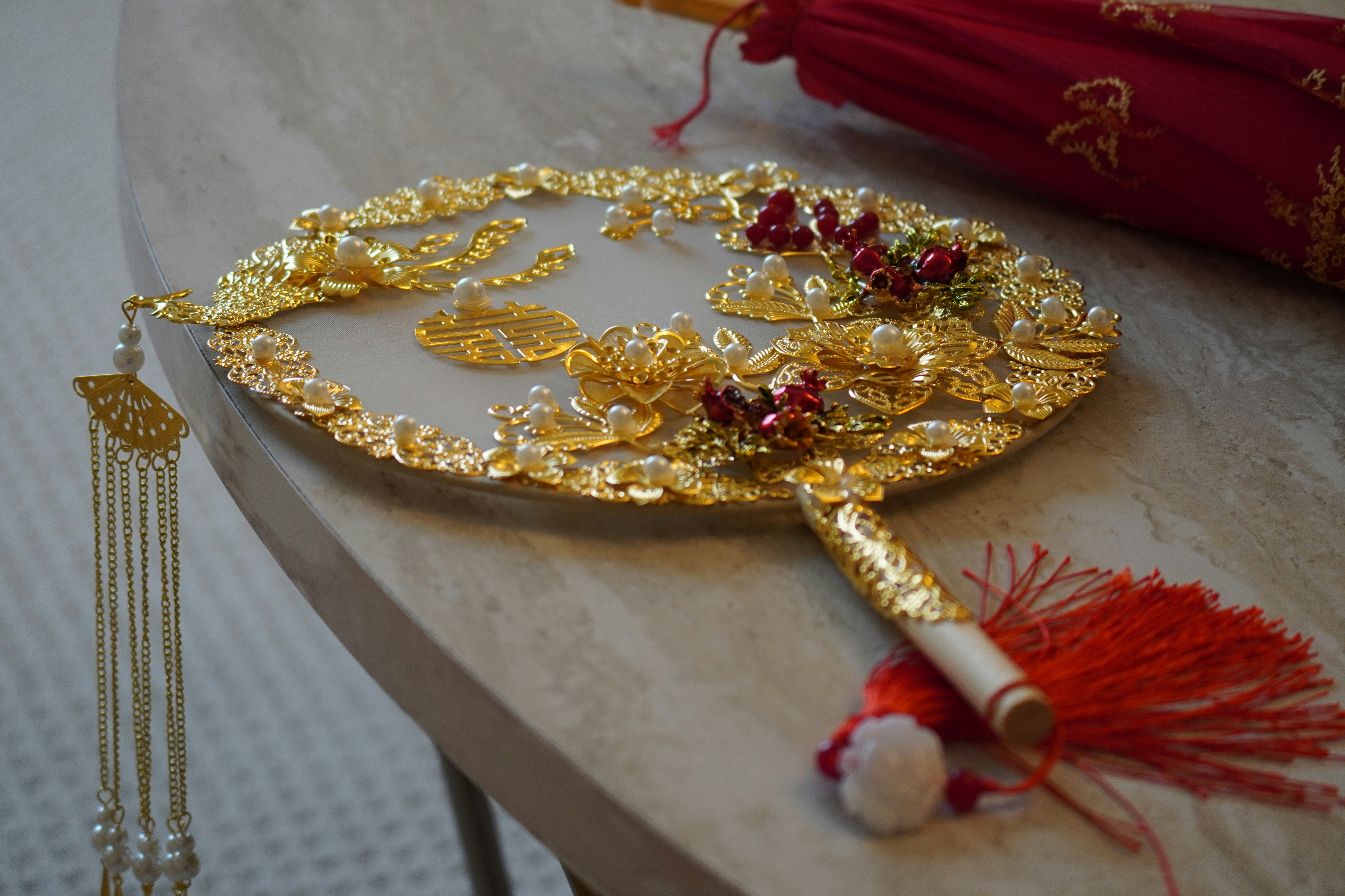 Elegant Artisan Hand Fan on a Marble Surface