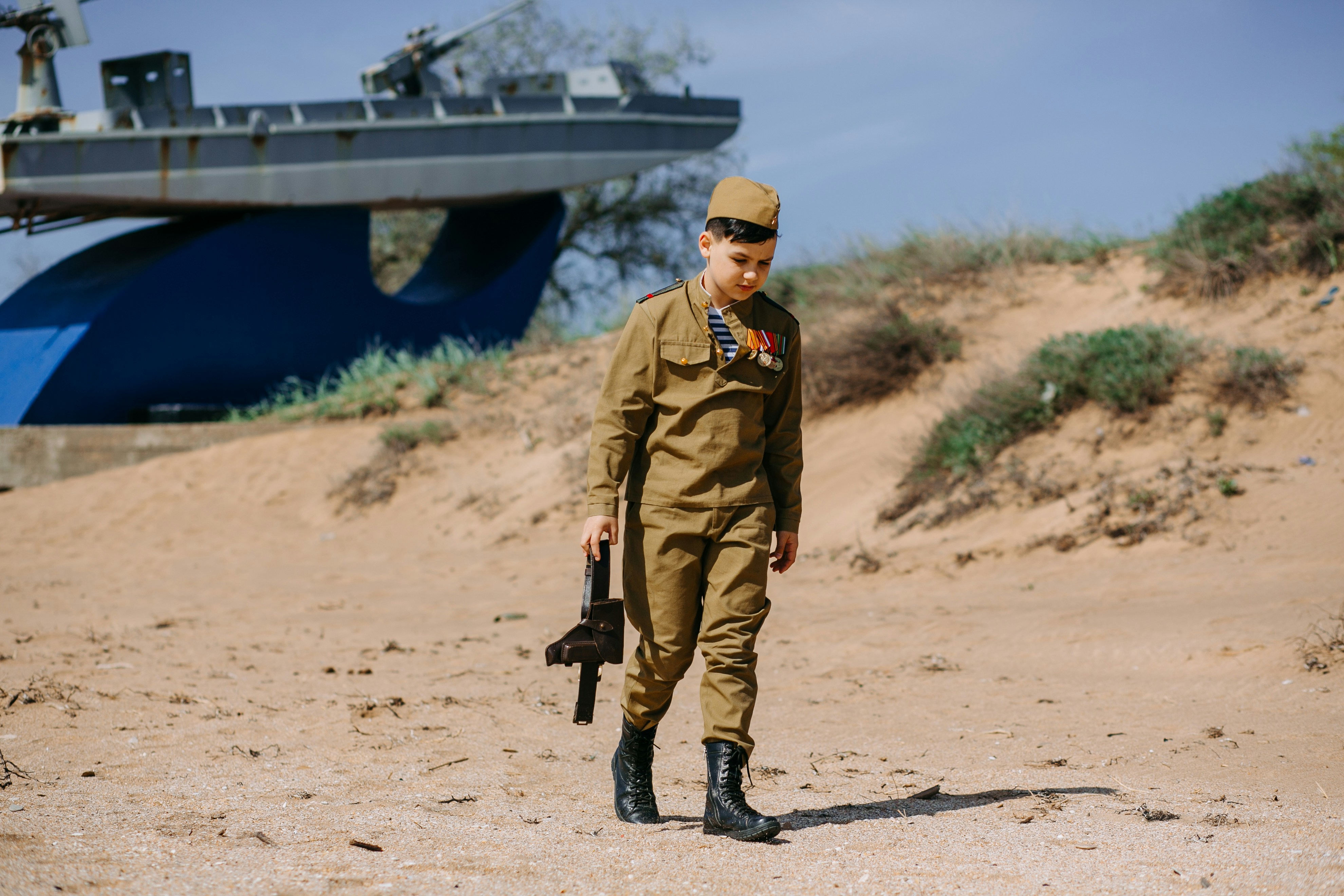Commanding Stance on the Sand: A Soldier Inspects the Shoreline