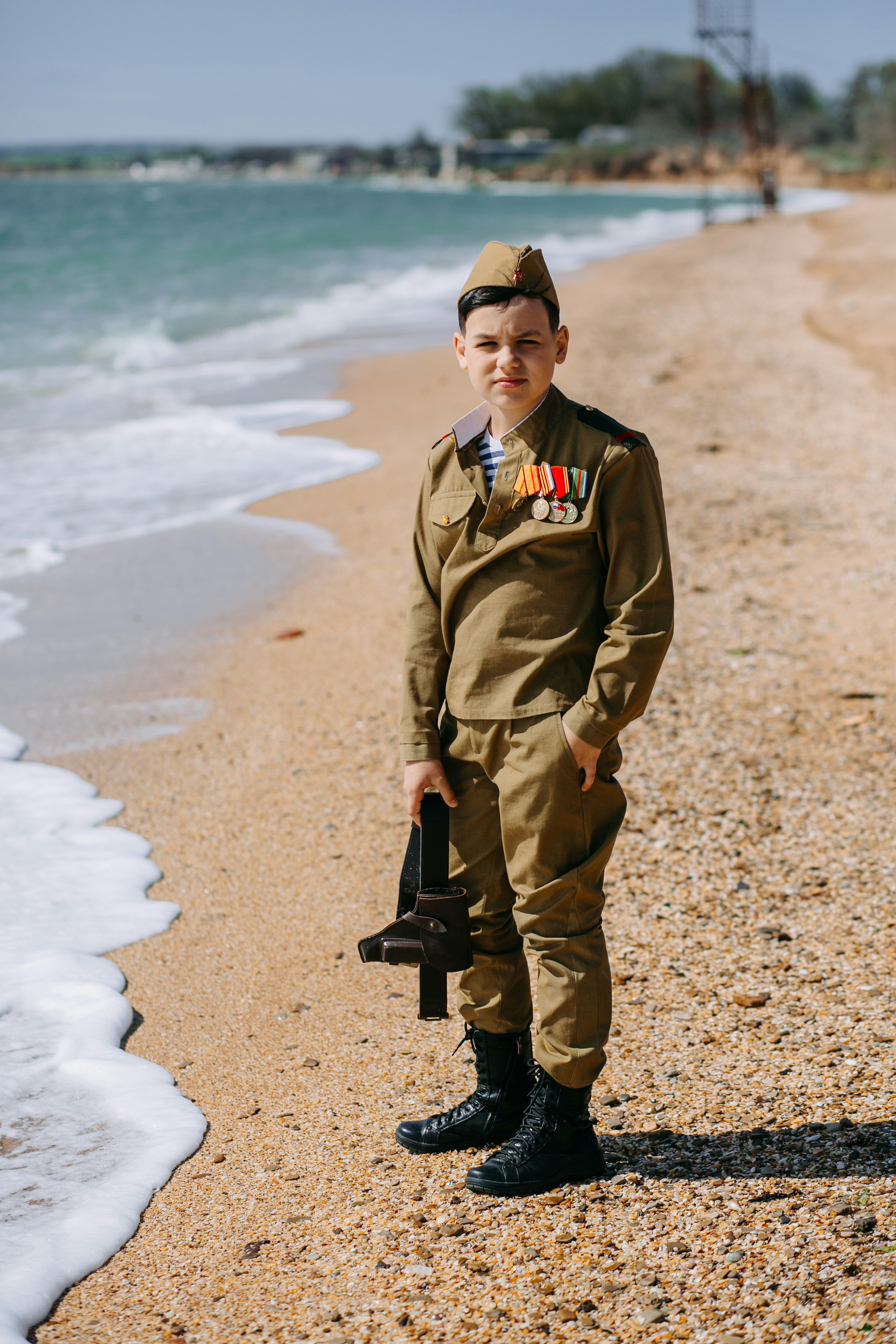 Young Veteran on the Shore: A Dressed Soldier Stands Quietly at the Waterline