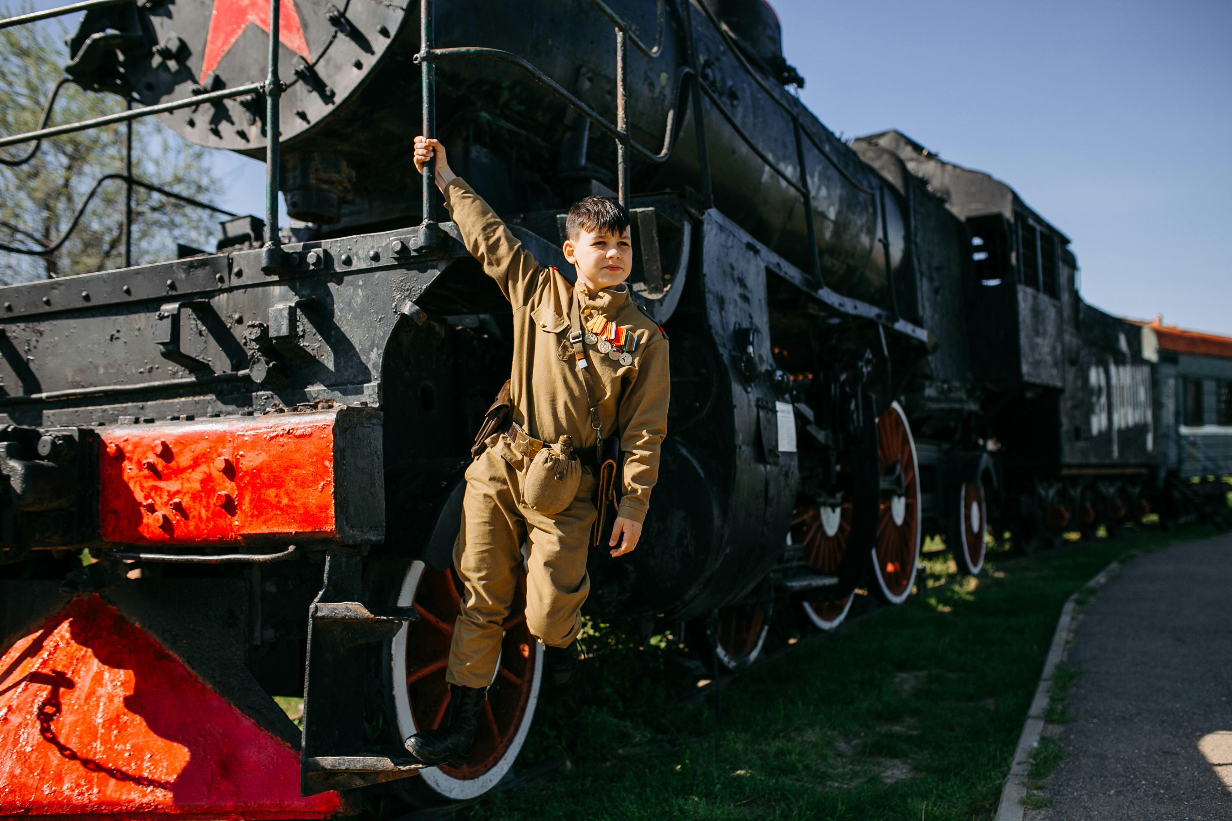 Young Scout in Front of a Steam Locomotive