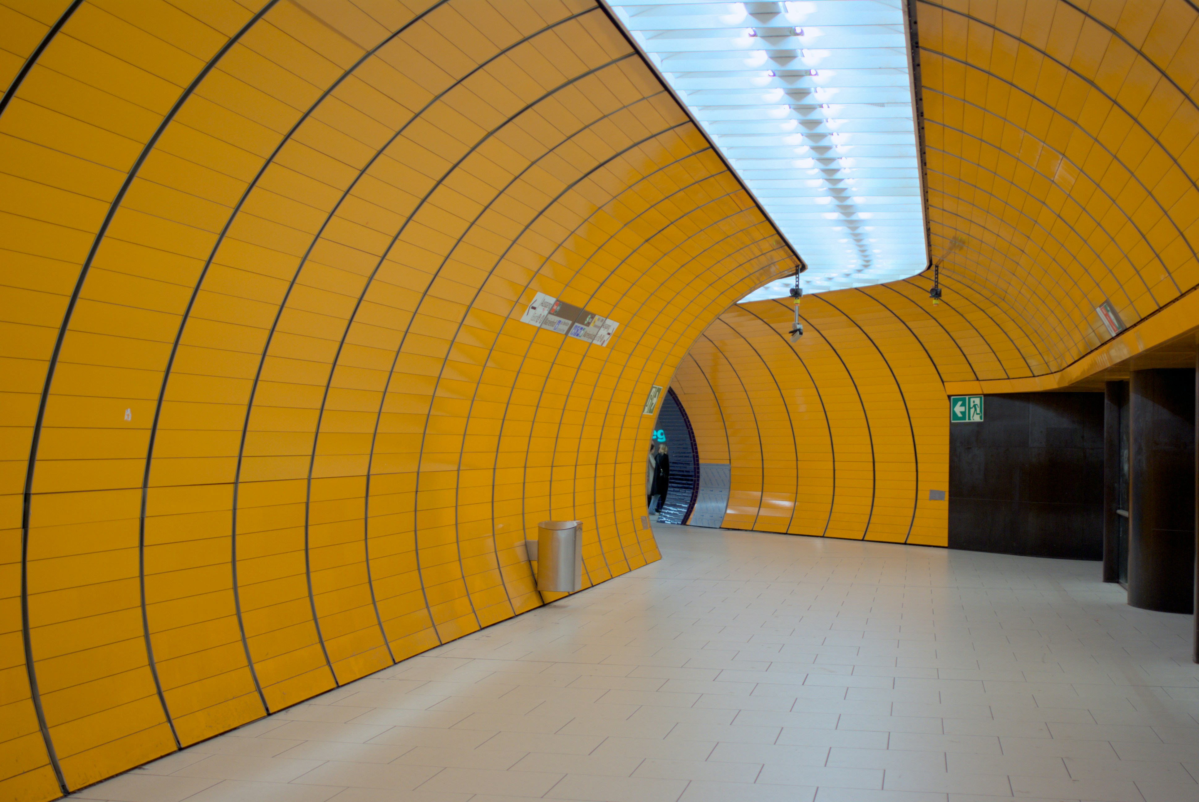 A yellow tunnel with a white tiled floor photo – Free München Image on ...