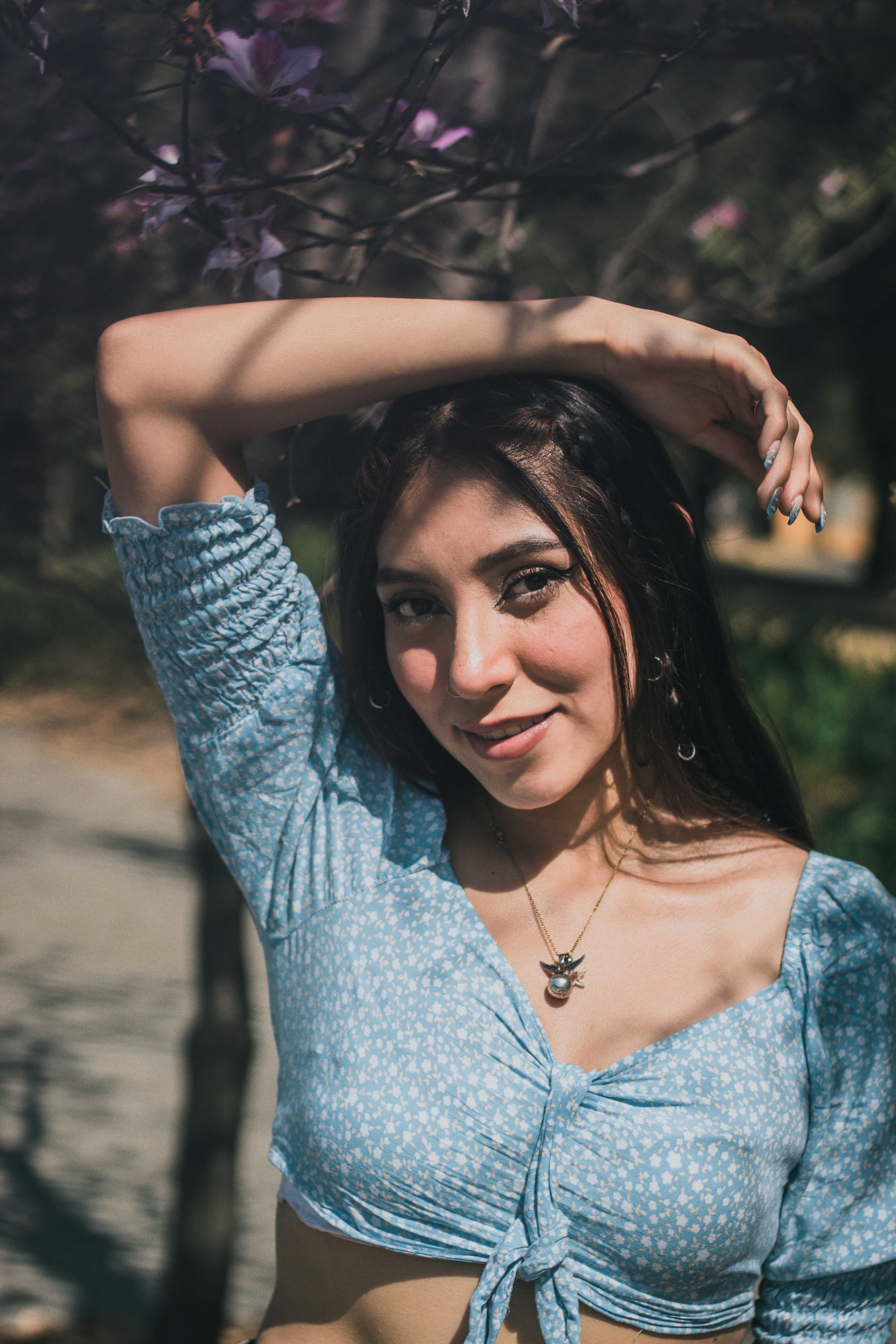 A woman in a blue top posing for a picture photo – Free Face Image on ...