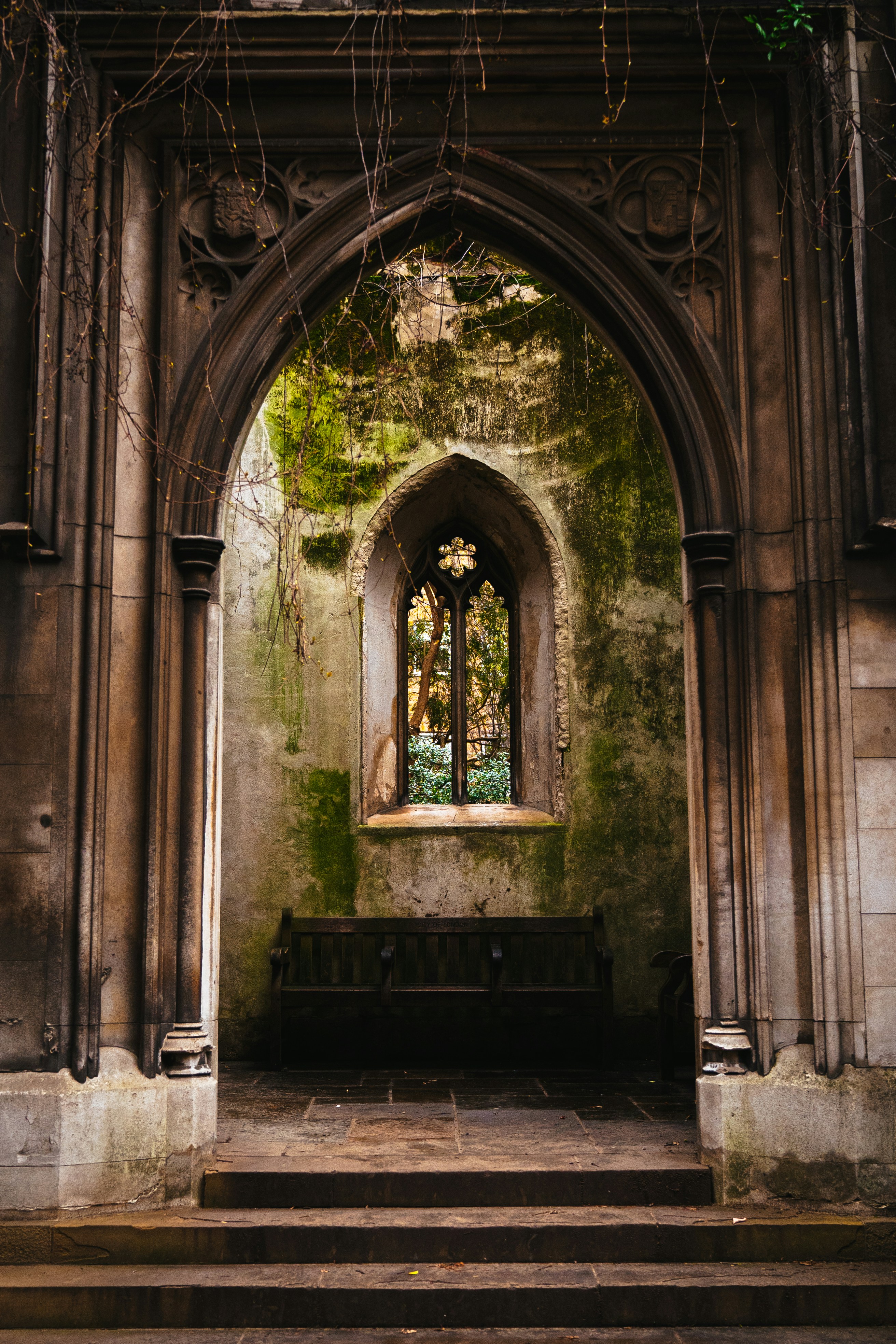 An old church with a stone alter and a stained glass window photo ...
