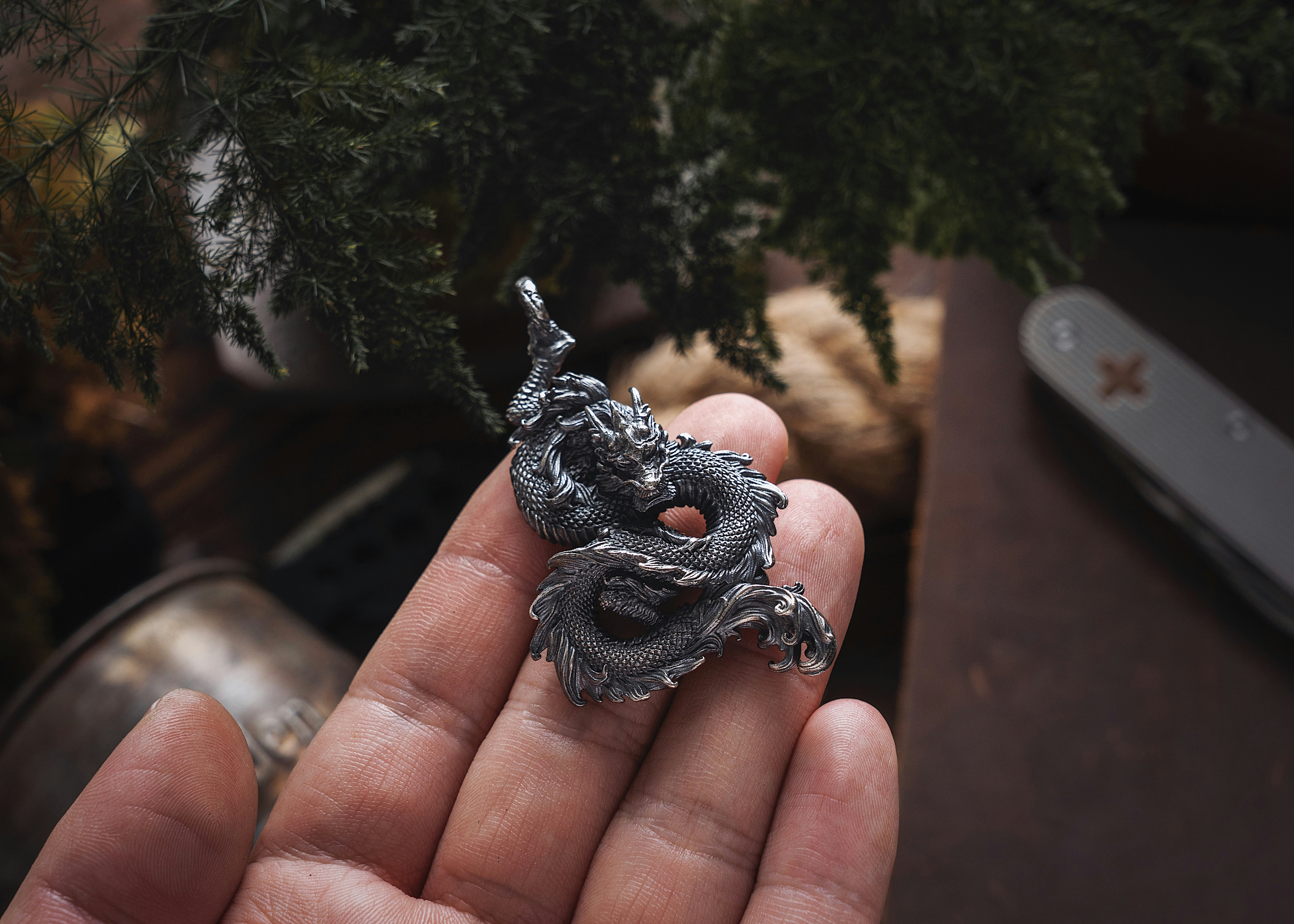 A person holding a small dragon ring in their hand photo – Free Hand Image on Unsplash