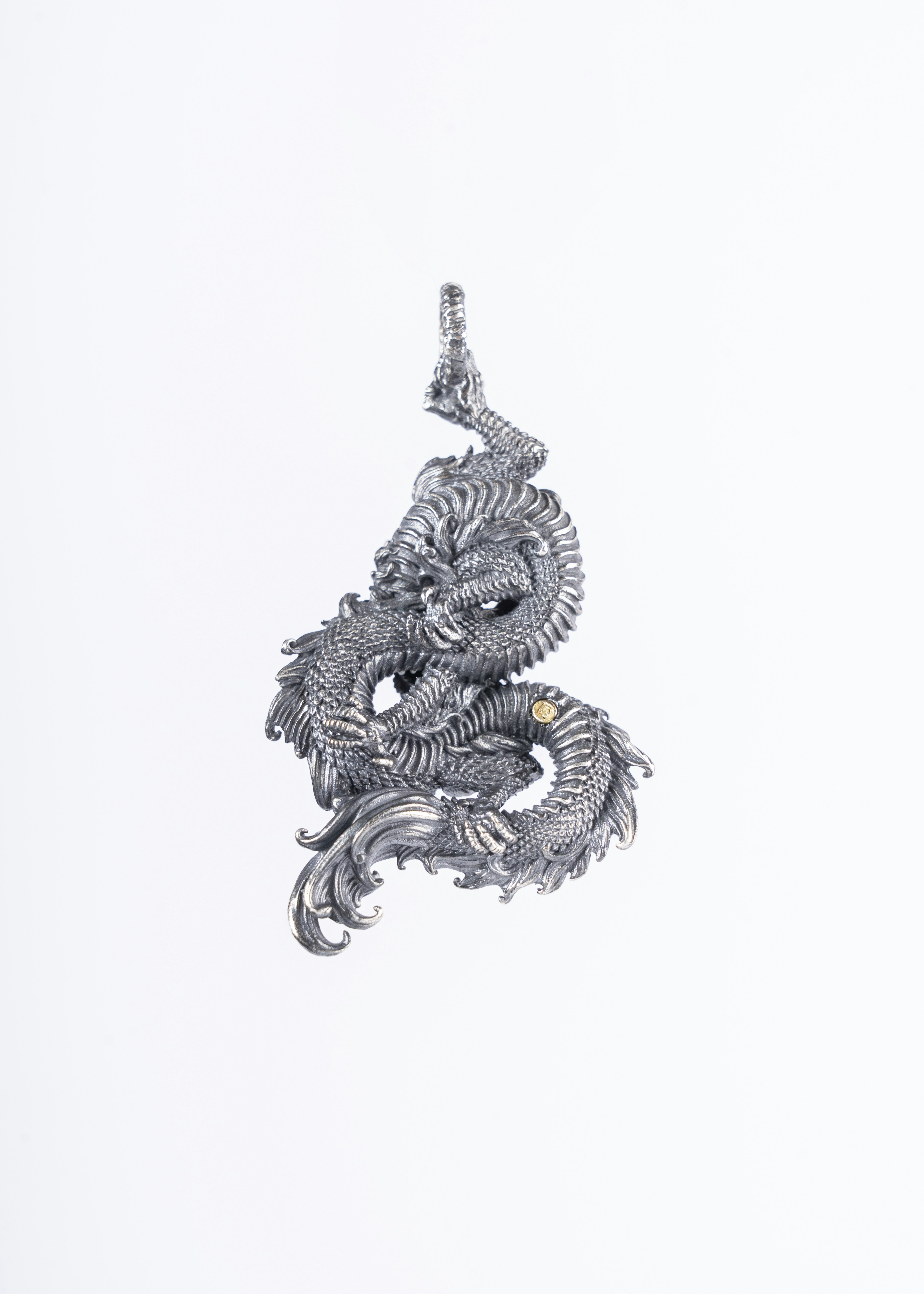 A silver statue of a dragon on a white background photo – Free ...