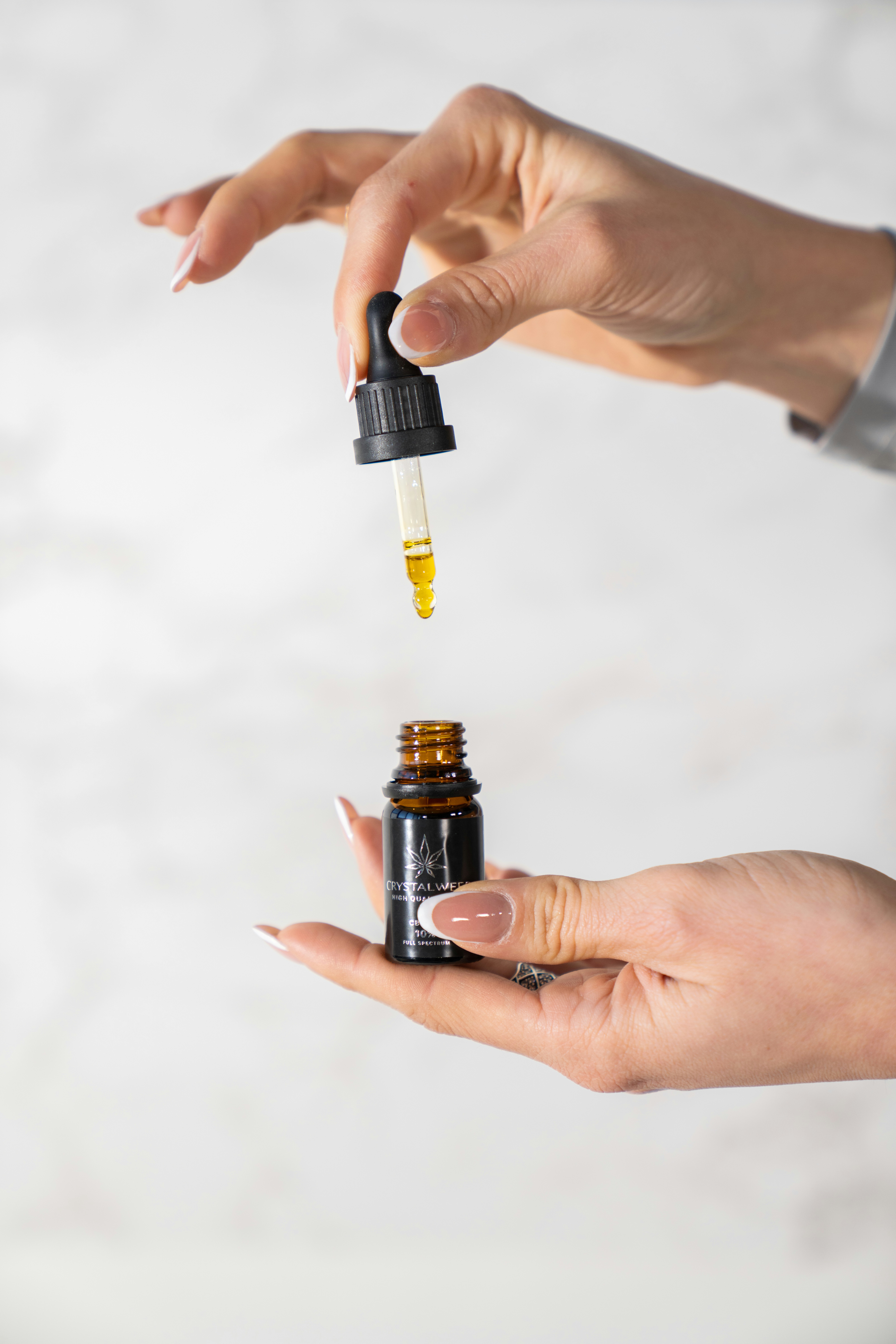 A person holding a bottle with a dropper in it photo – Free Wellness ...