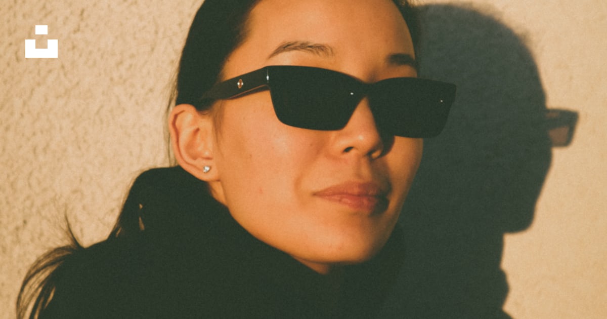 Foto Una Mujer Con Gafas De Sol Parada Junto A Una Pared Imagen Issyk