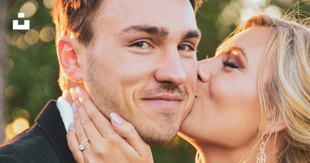 A Man And A Woman Kissing Each Other Photo Free Kissing Image On Unsplash
