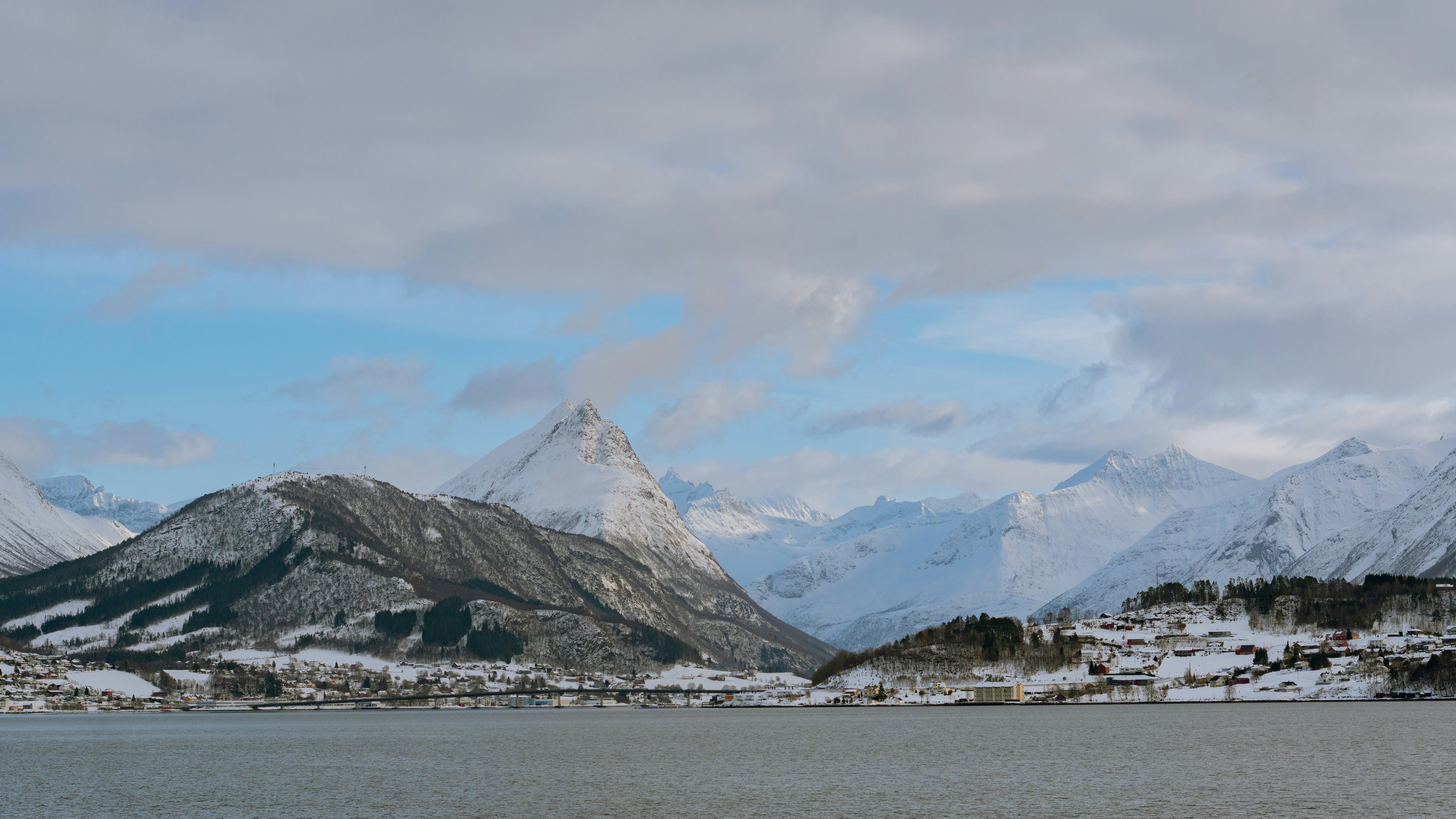 The Needle Peak and the Quiet Lake: Snowbound Vistas Framing a Mountain Village