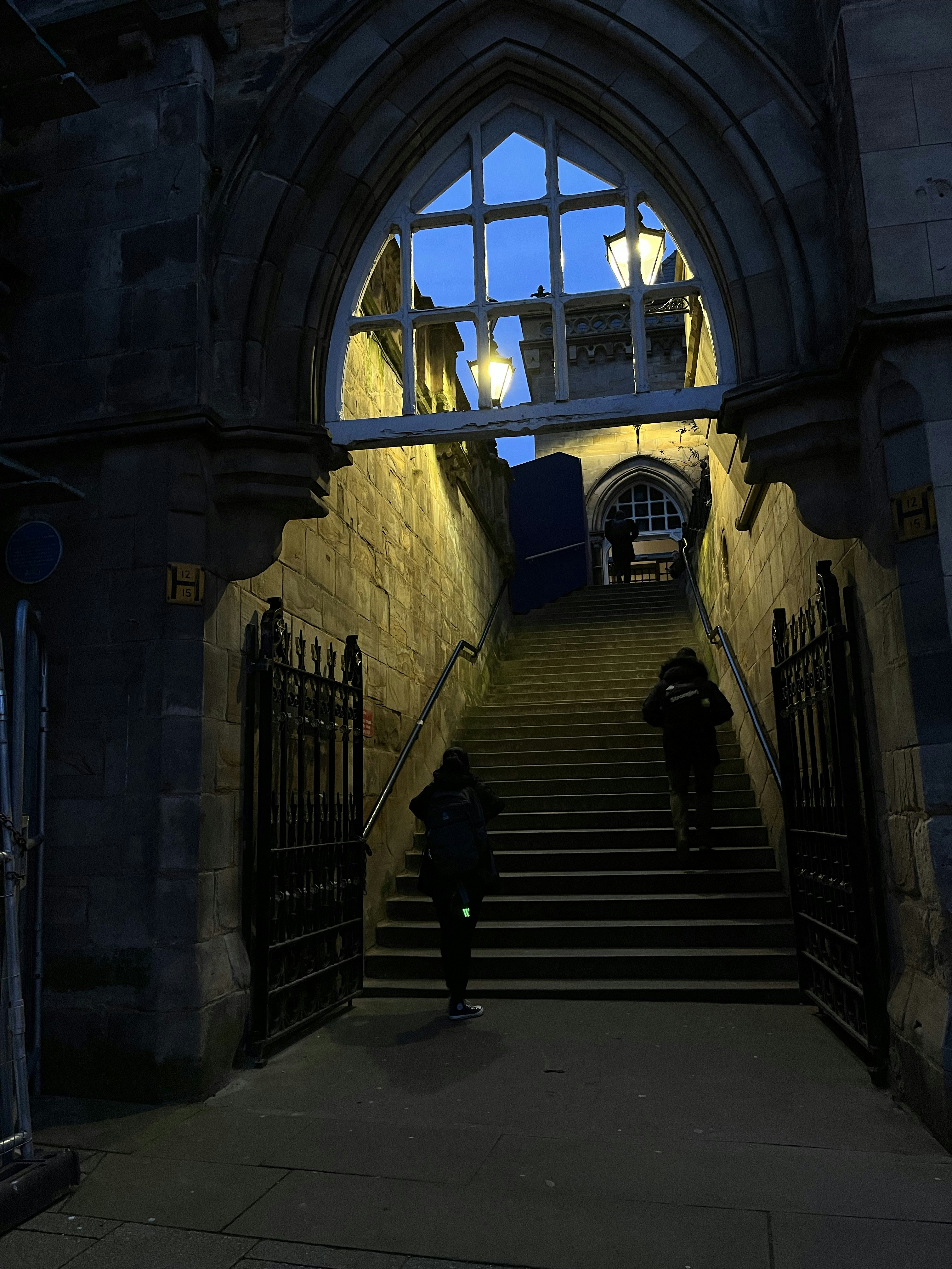 A person walking up a set of stairs at night photo – Free Wallpaper for ...