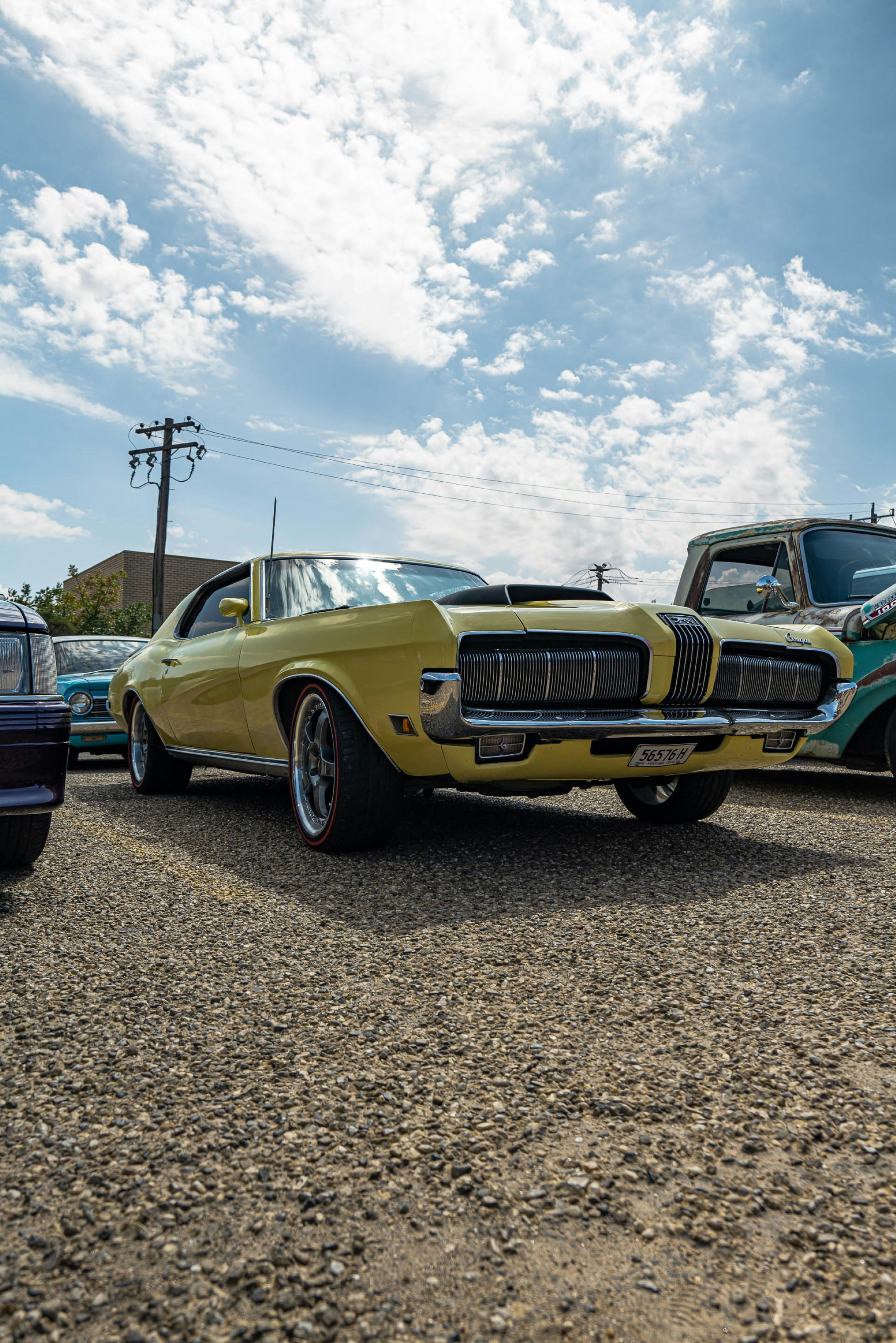 Sunlit Muscle: A yellow classic car under a bright sky