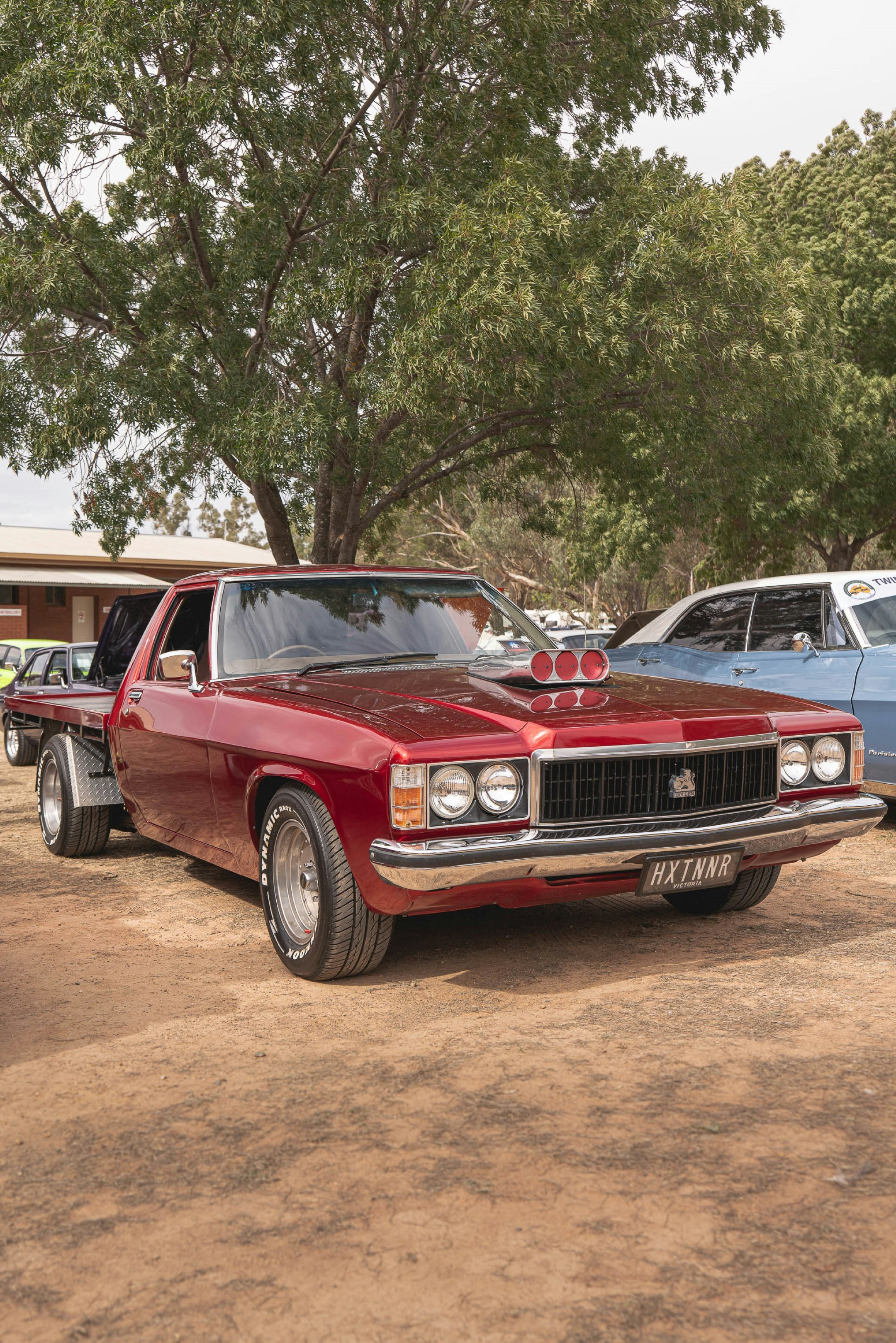 Chrome Crown: A Red Classic on a Dusty Lot