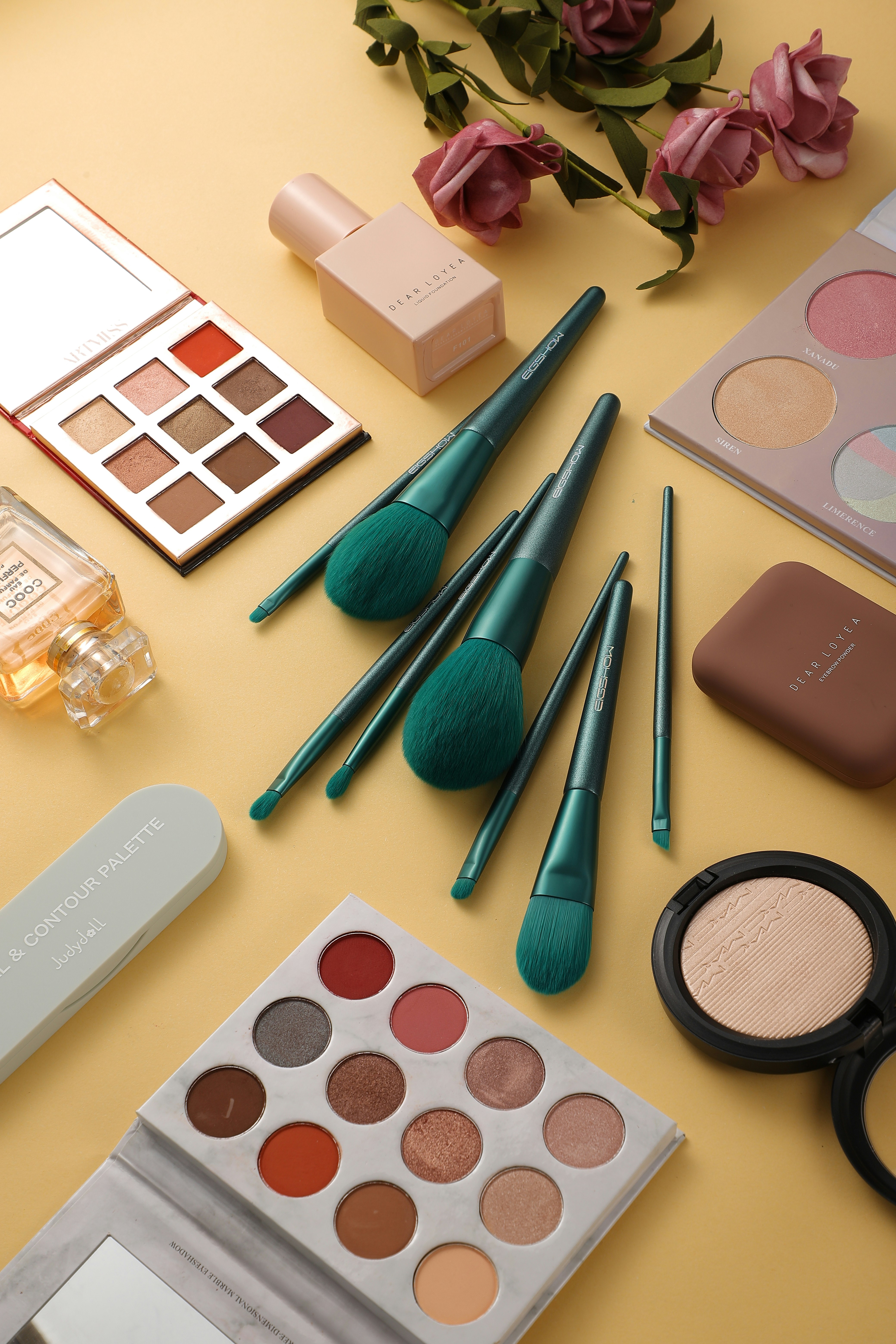 A collection of makeup and cosmetics on a table photo – Free Makeup ...