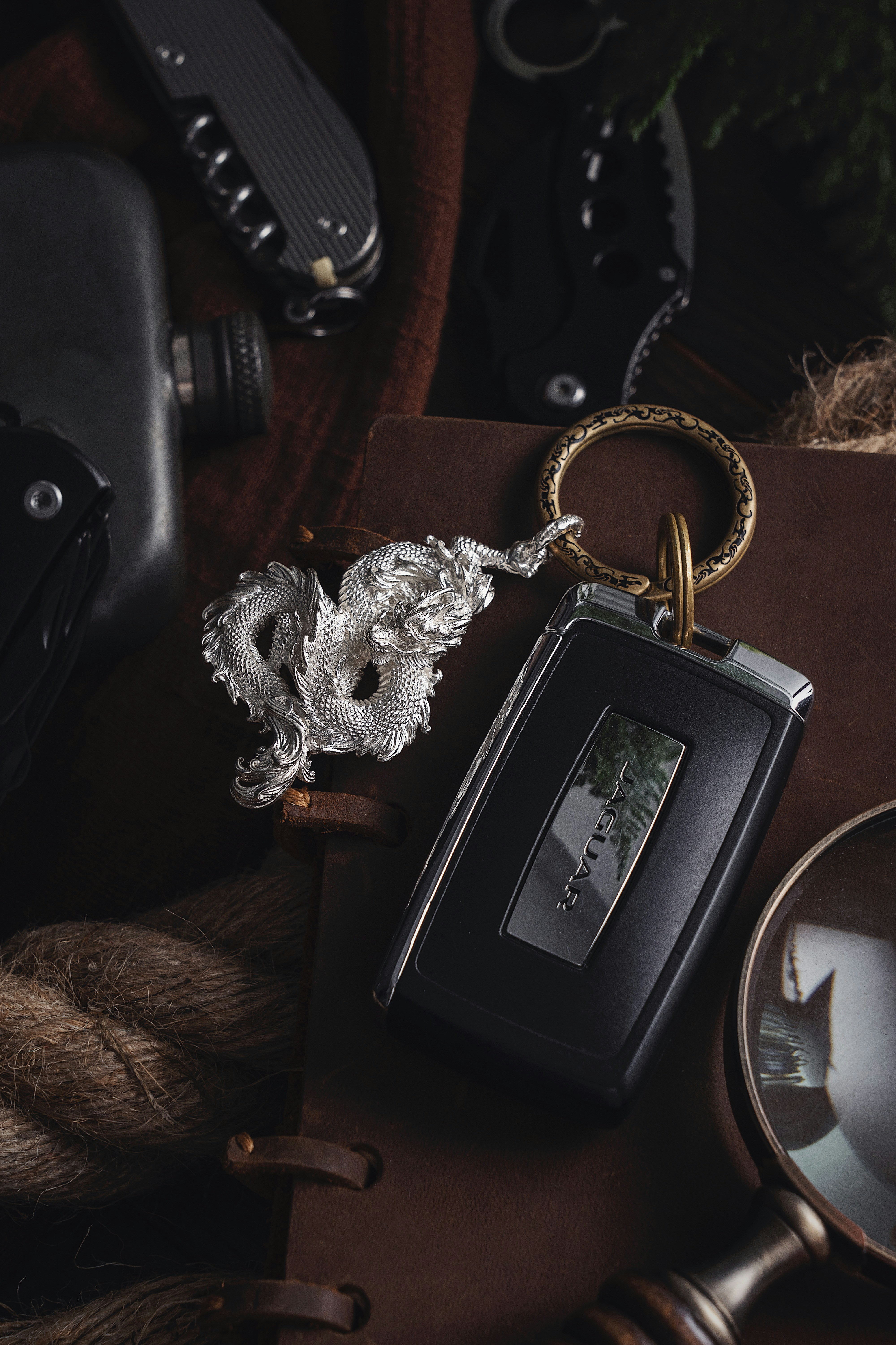 A keychain with a piece of cloth on it next to a magni photo – Free ...