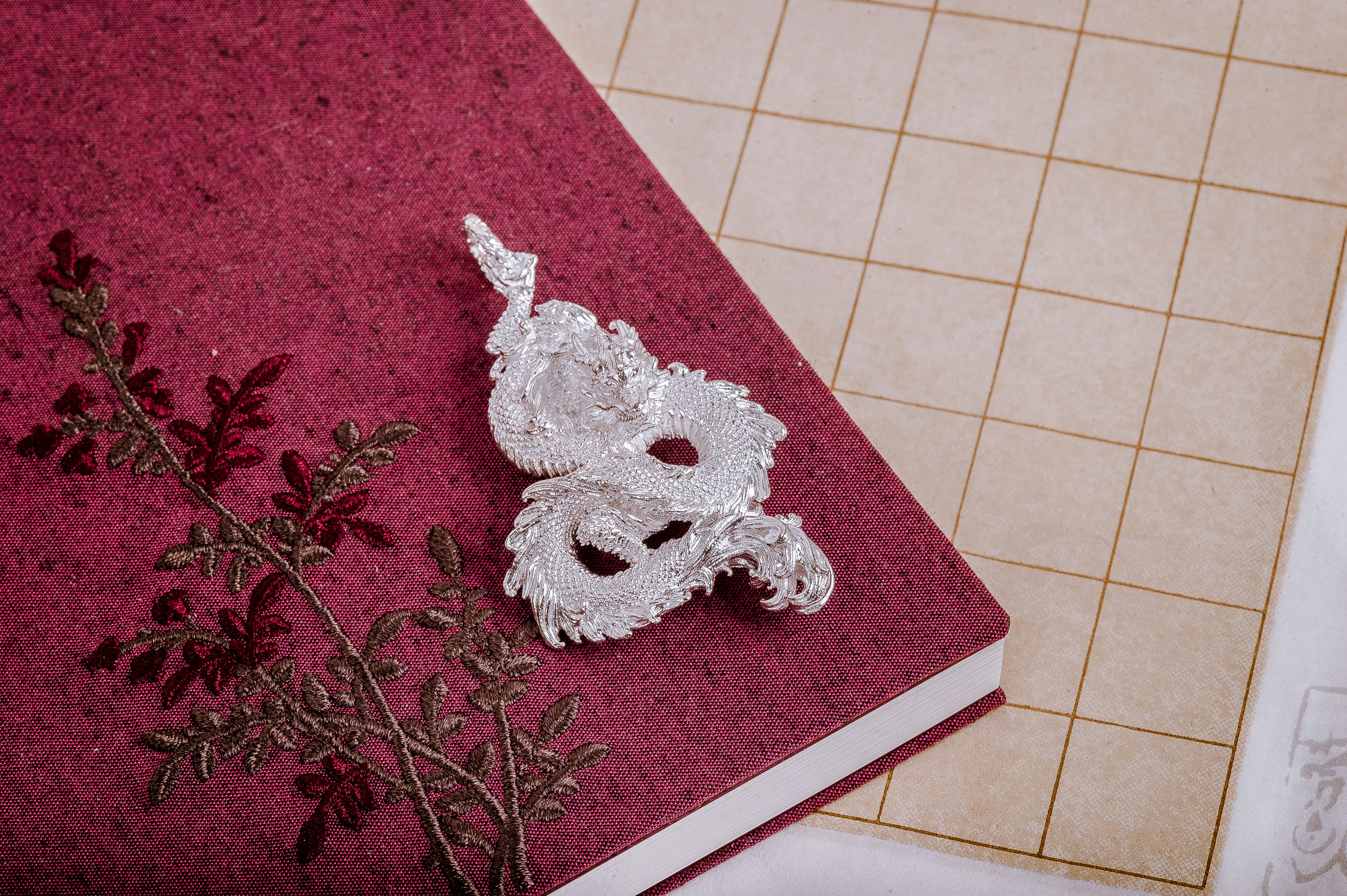 Ornate Clip Resting on a Textured Notebook