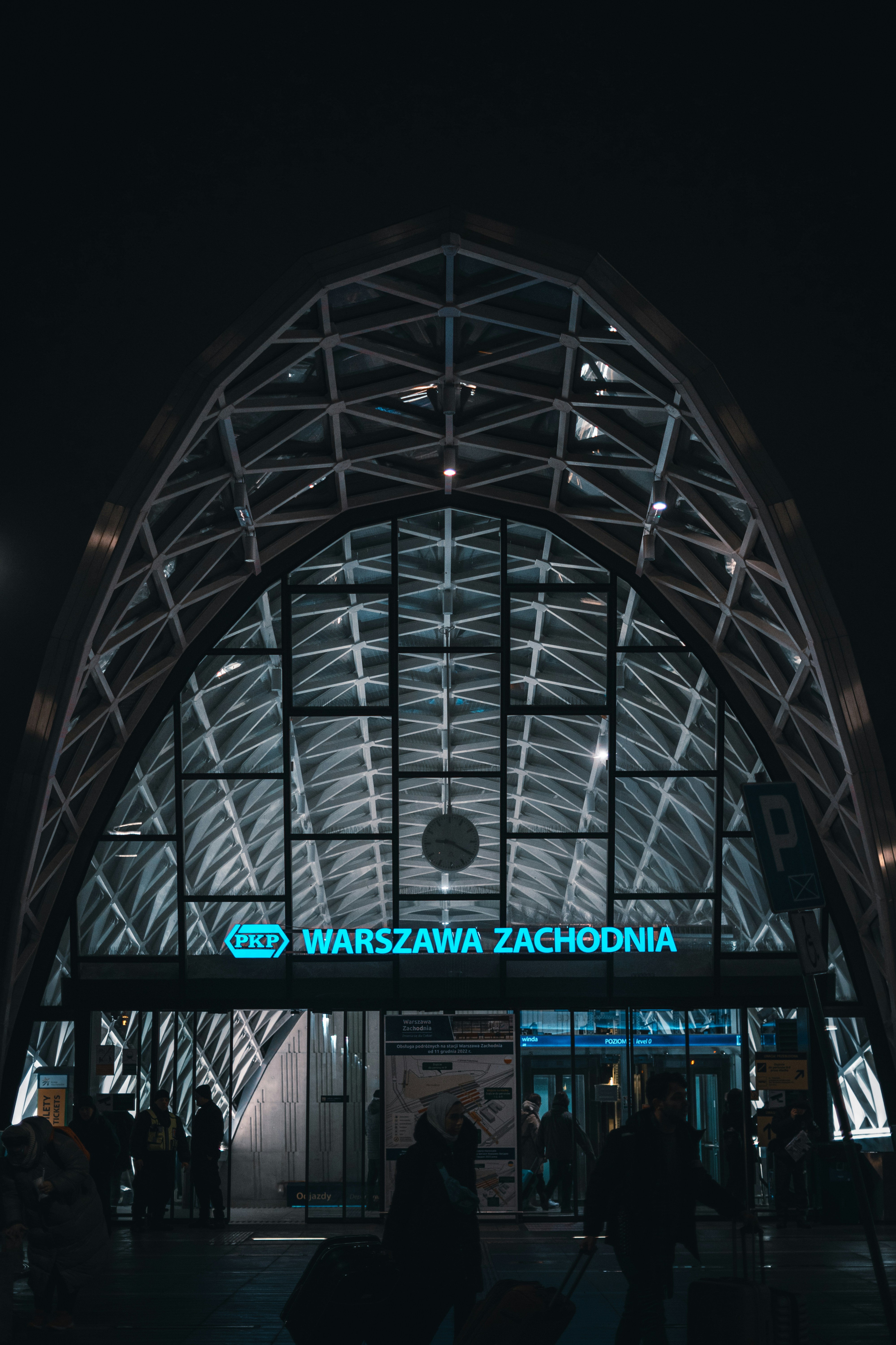 Blue Neon Threshold: Night Entrance Under Warsaw Zachodnia's Glass Arch