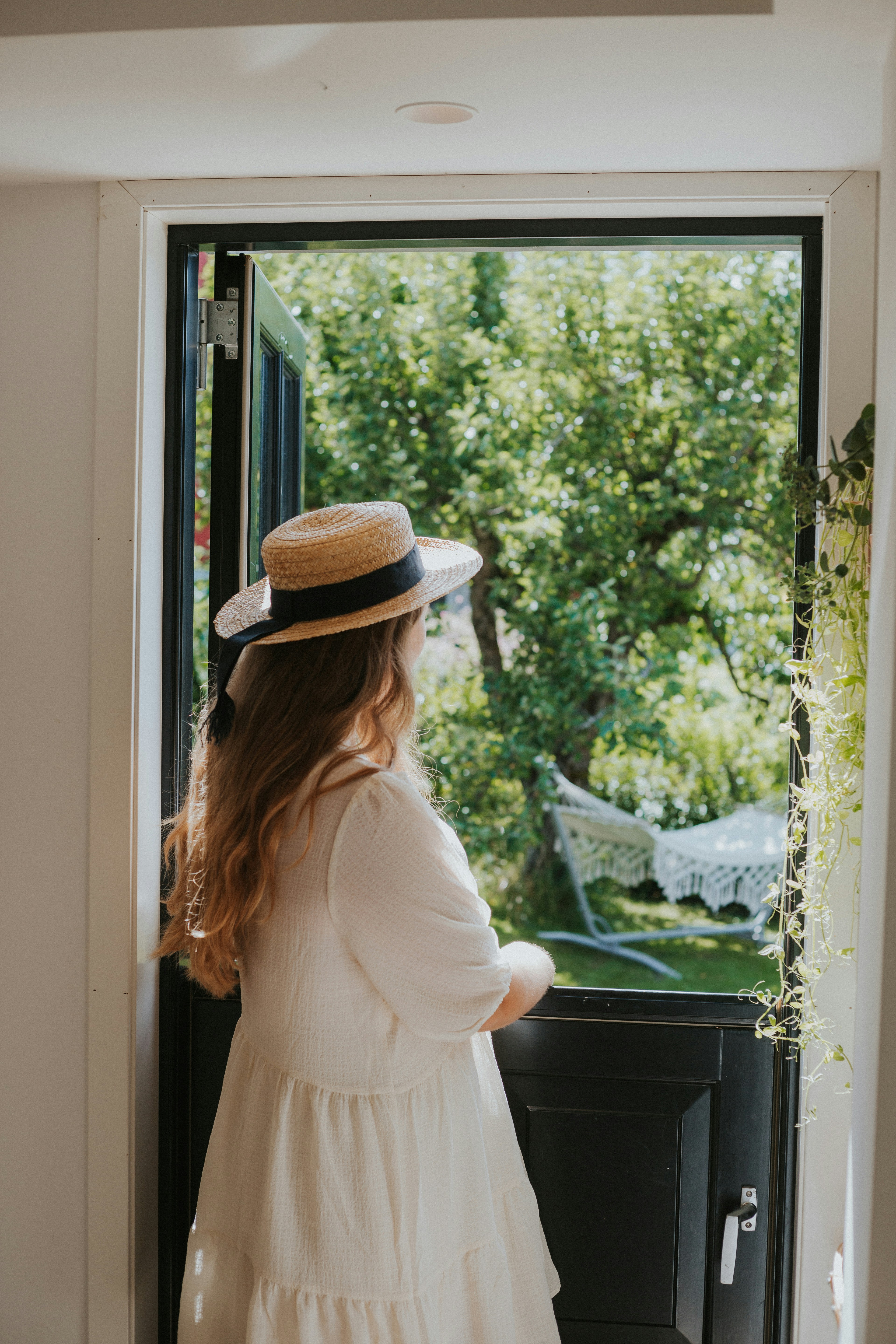 Open Door Reverie: Sunlit Veranda Portrait in White