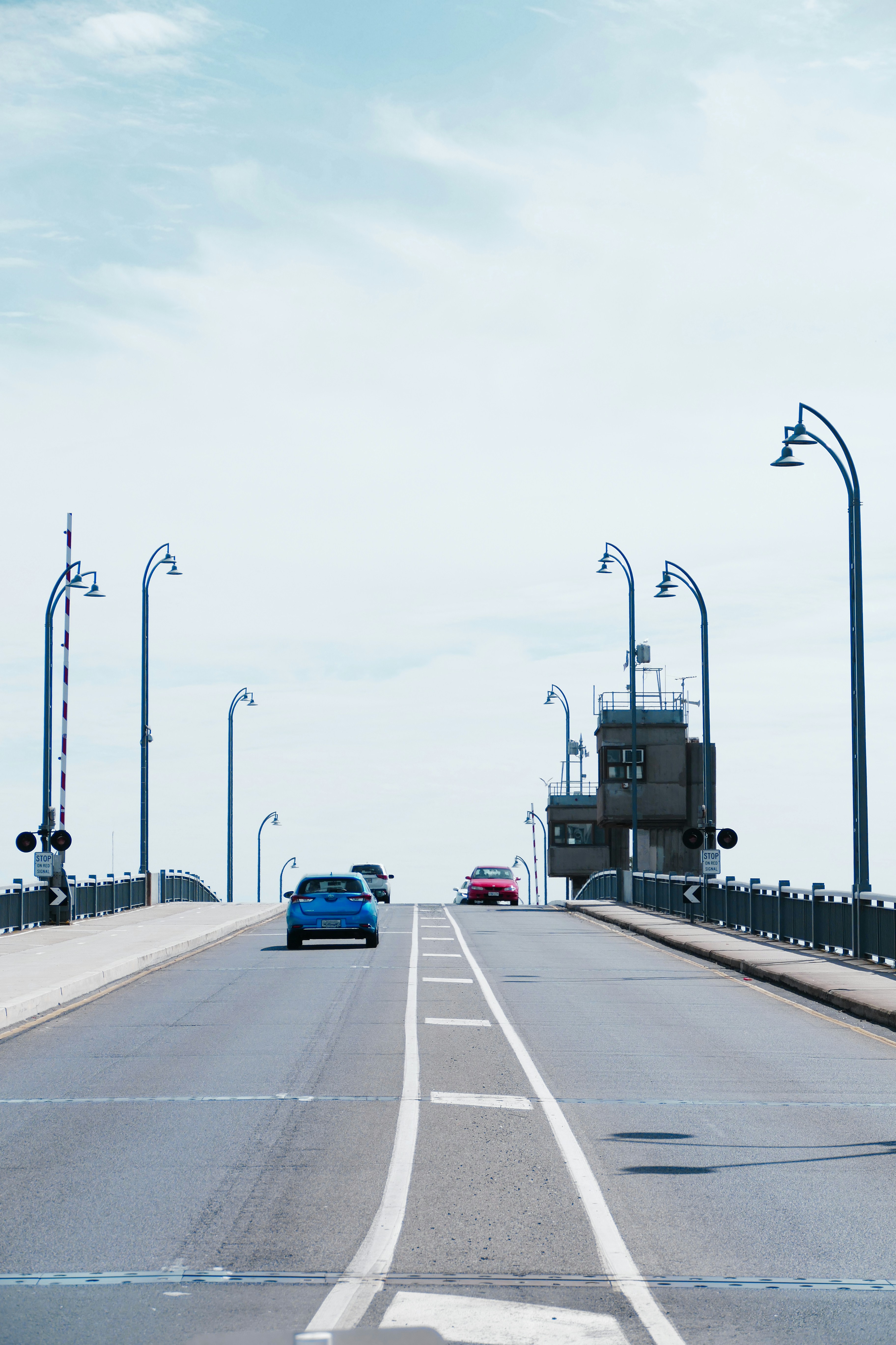 A blue car driving across a bridge over water photo – Free Birkenhead ...