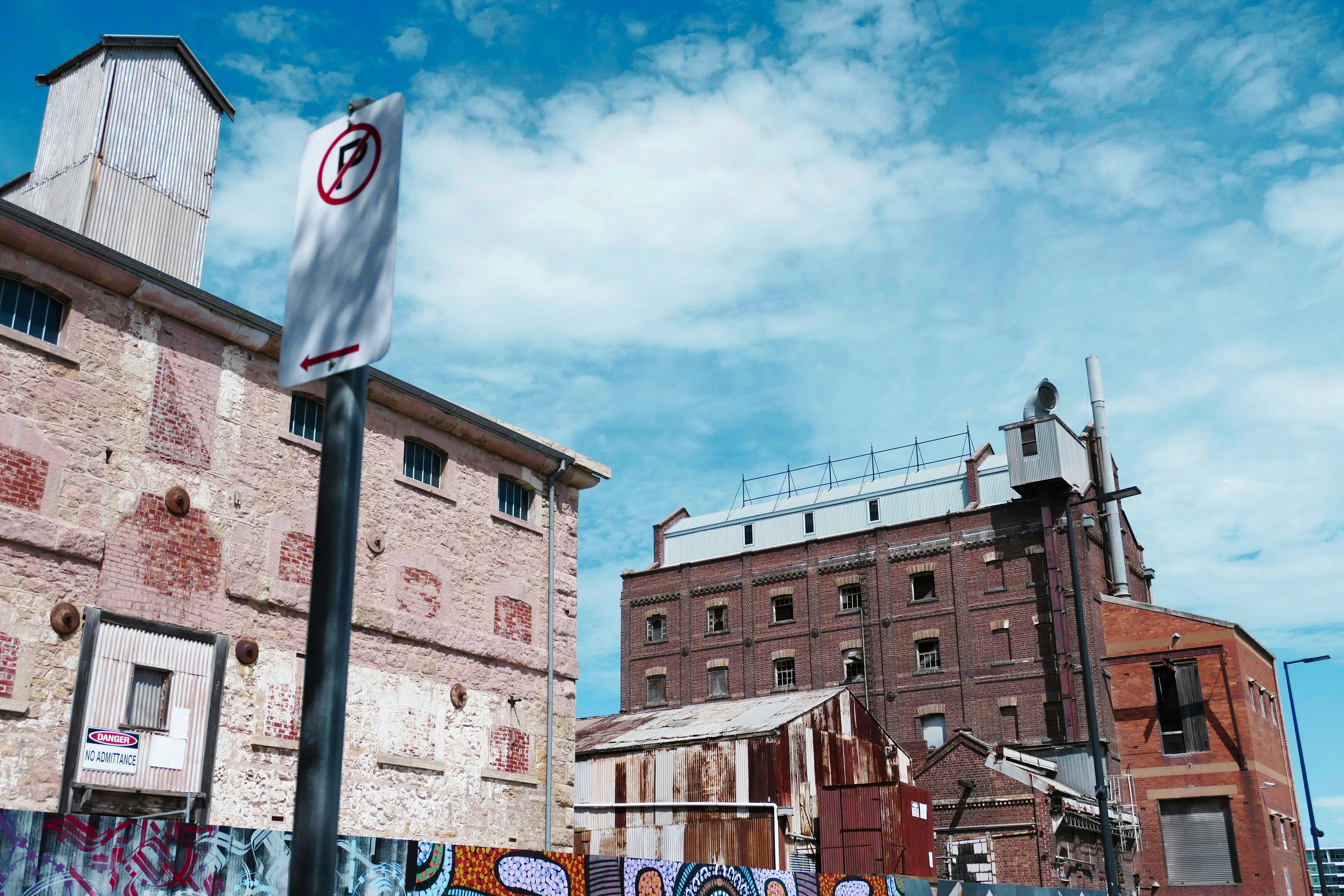Urban Decay and Facade Echoes: A Street Scene of Brick and Graffiti