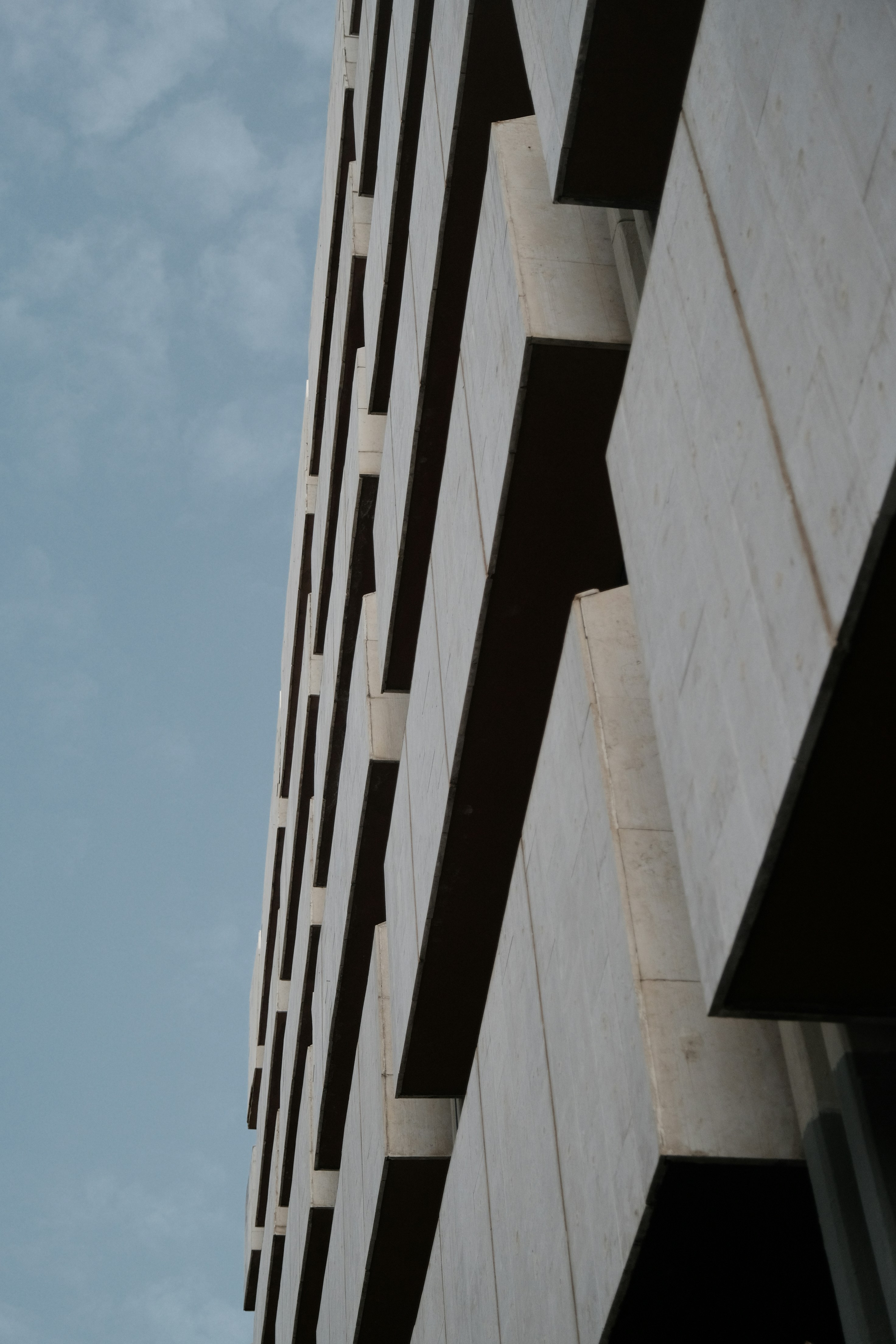 An airplane flying in the sky over a building photo – Free Israel Image ...