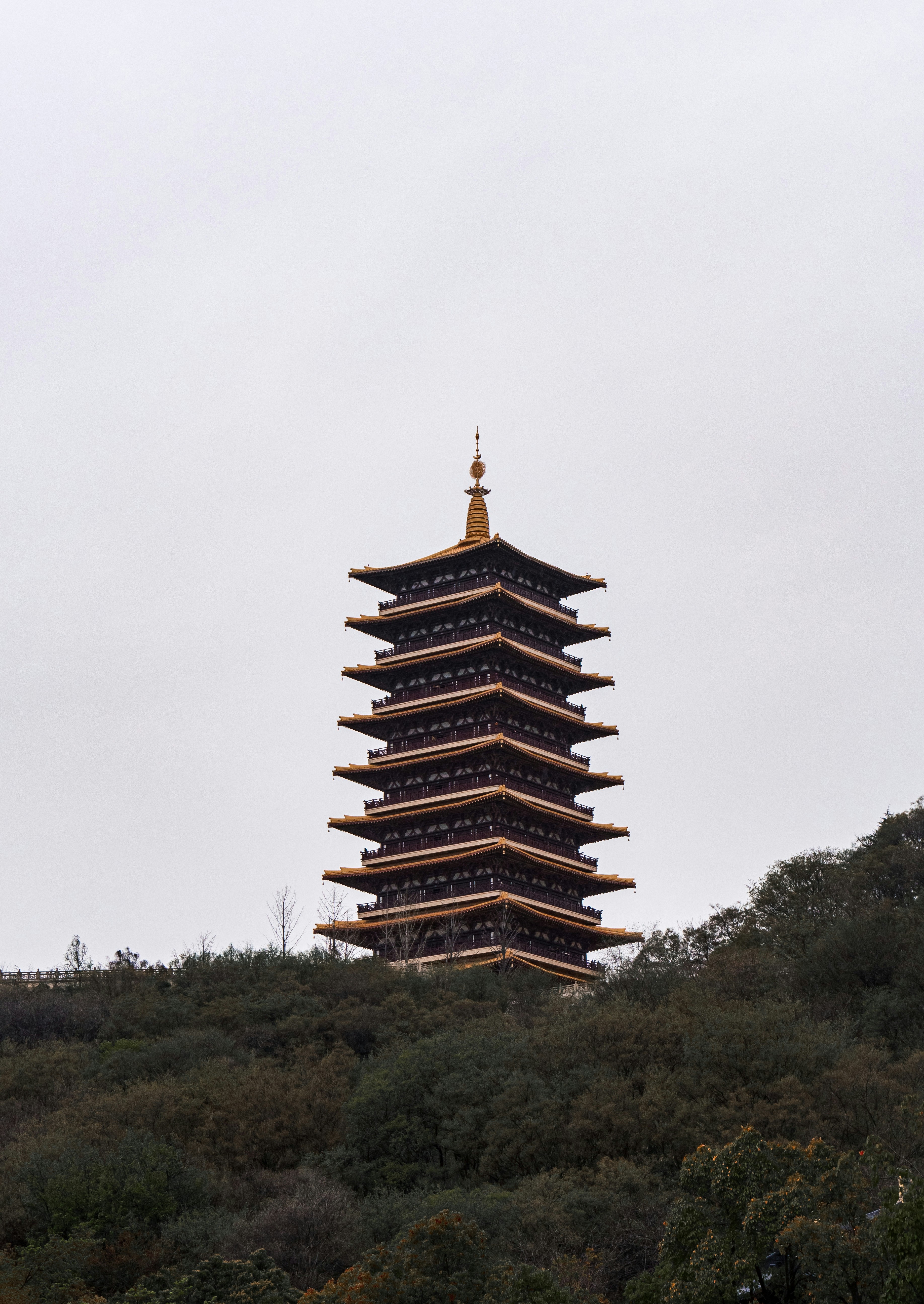 a tall tower sitting on top of a lush green hillside