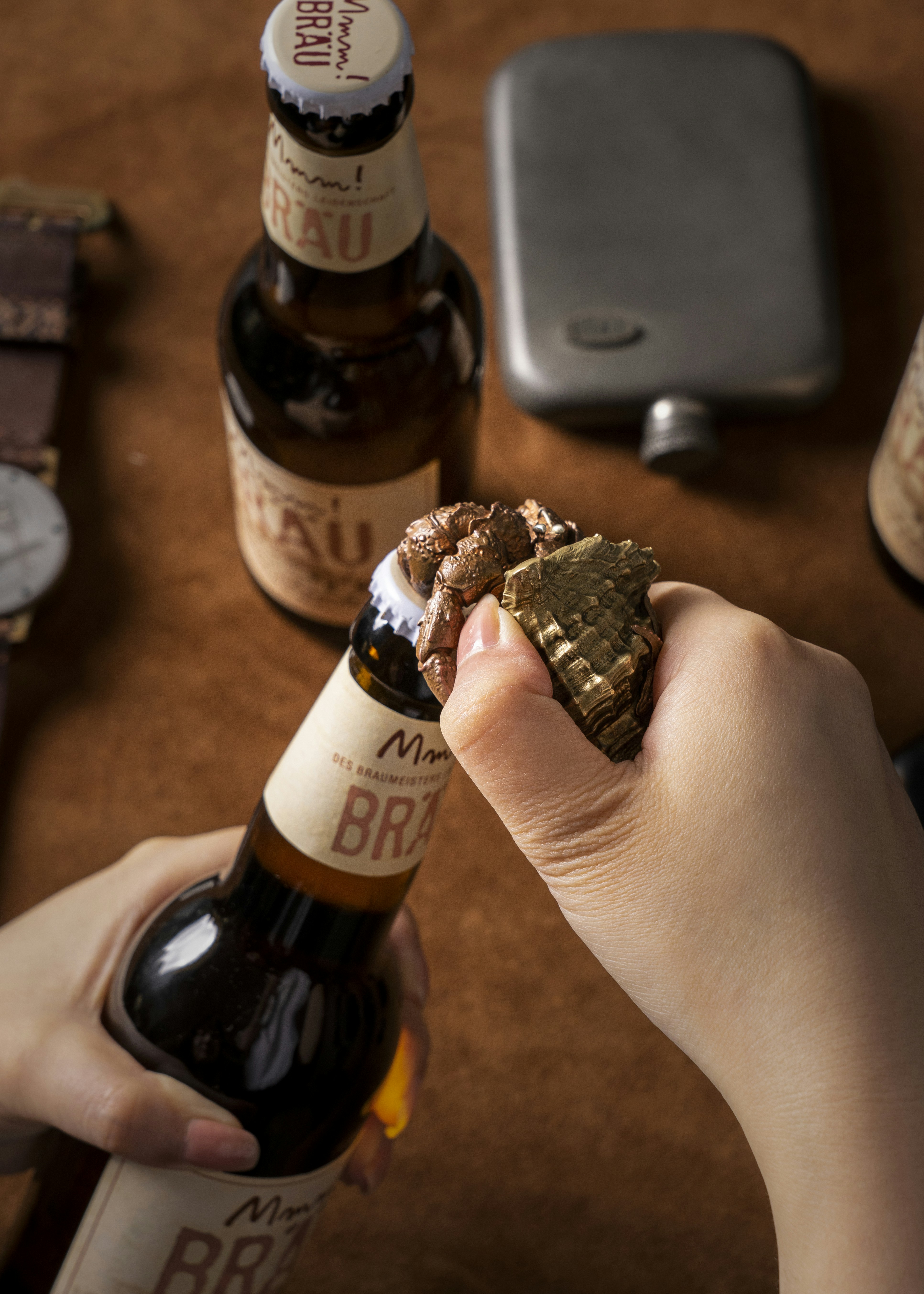 Uncapping BRAU: a close-up moment of hands at a rustic table